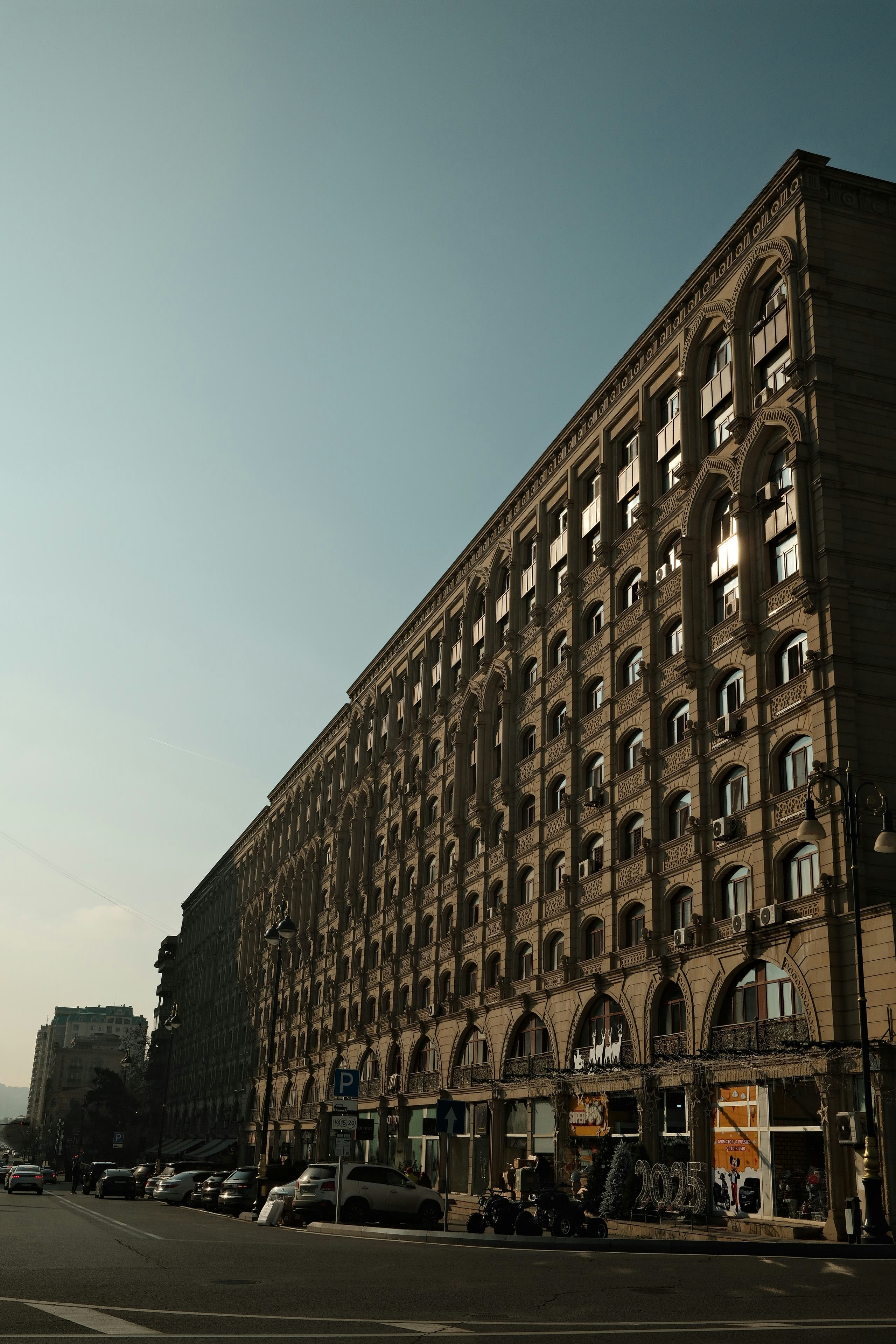 Sunlit Arcades: A Diagonal Facade Guardian of the Street