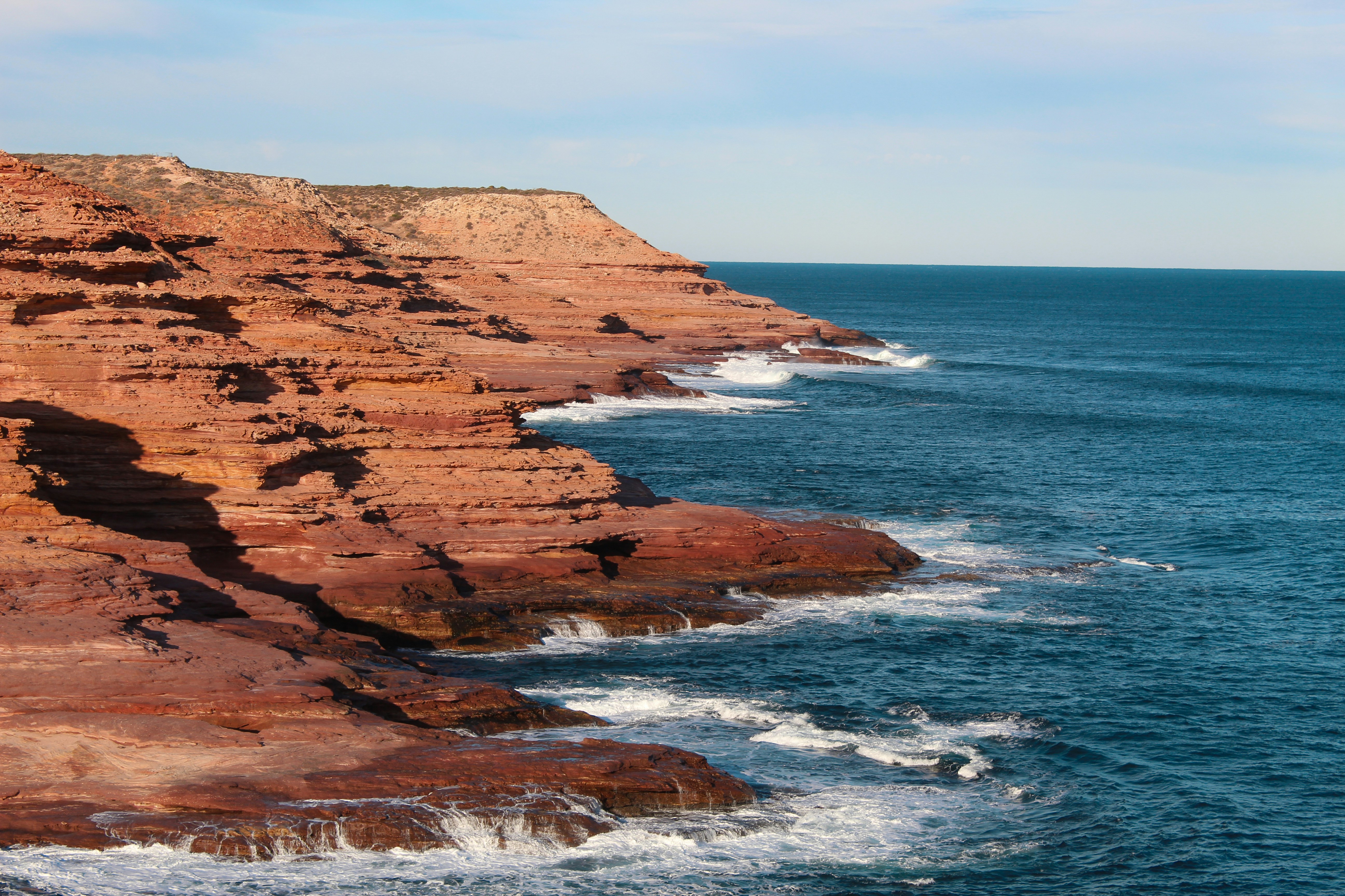 Crimson Cliffs Meeting the Endless Blue