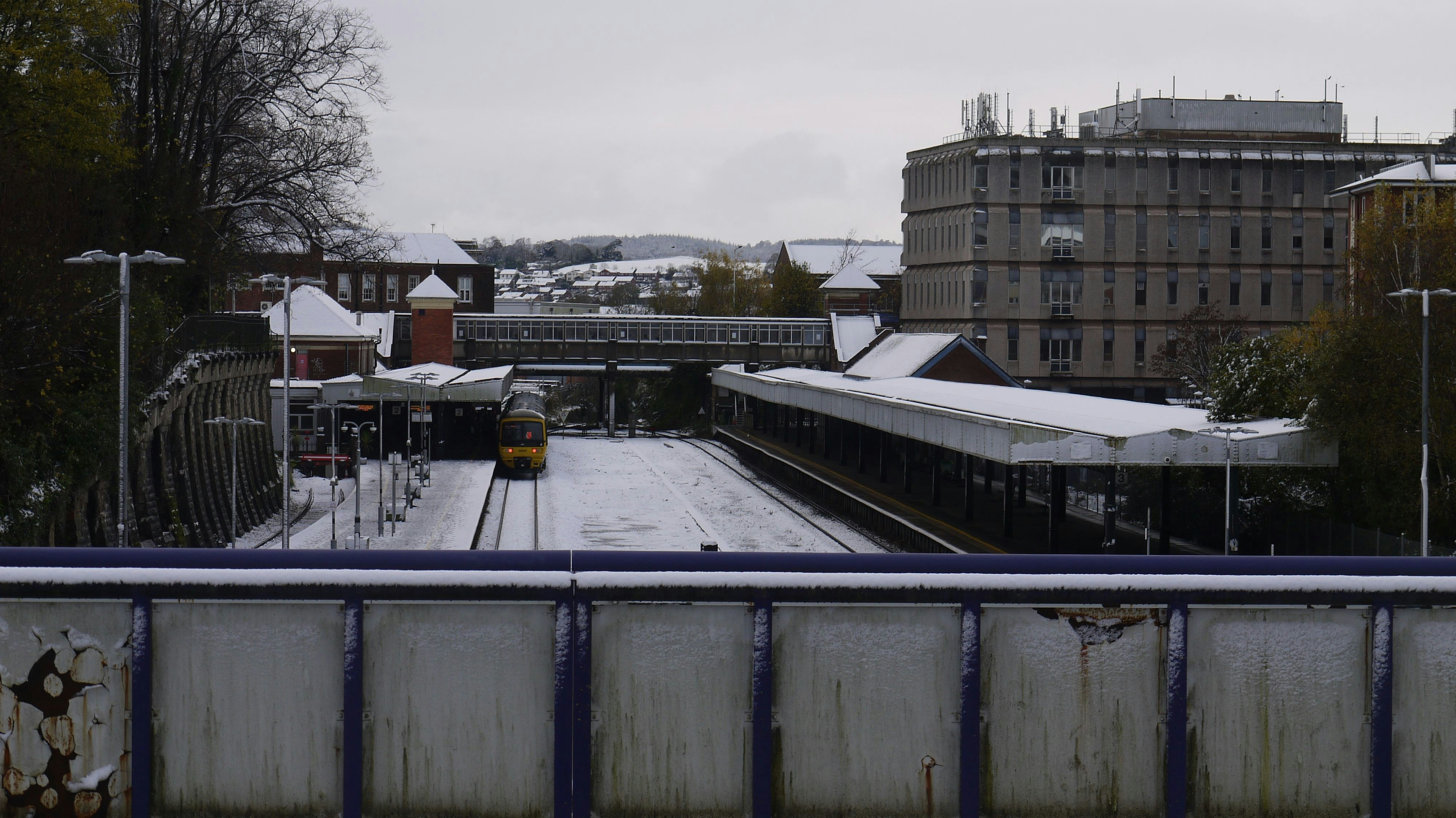 Snowbound Train Platform with Urban Backdrop