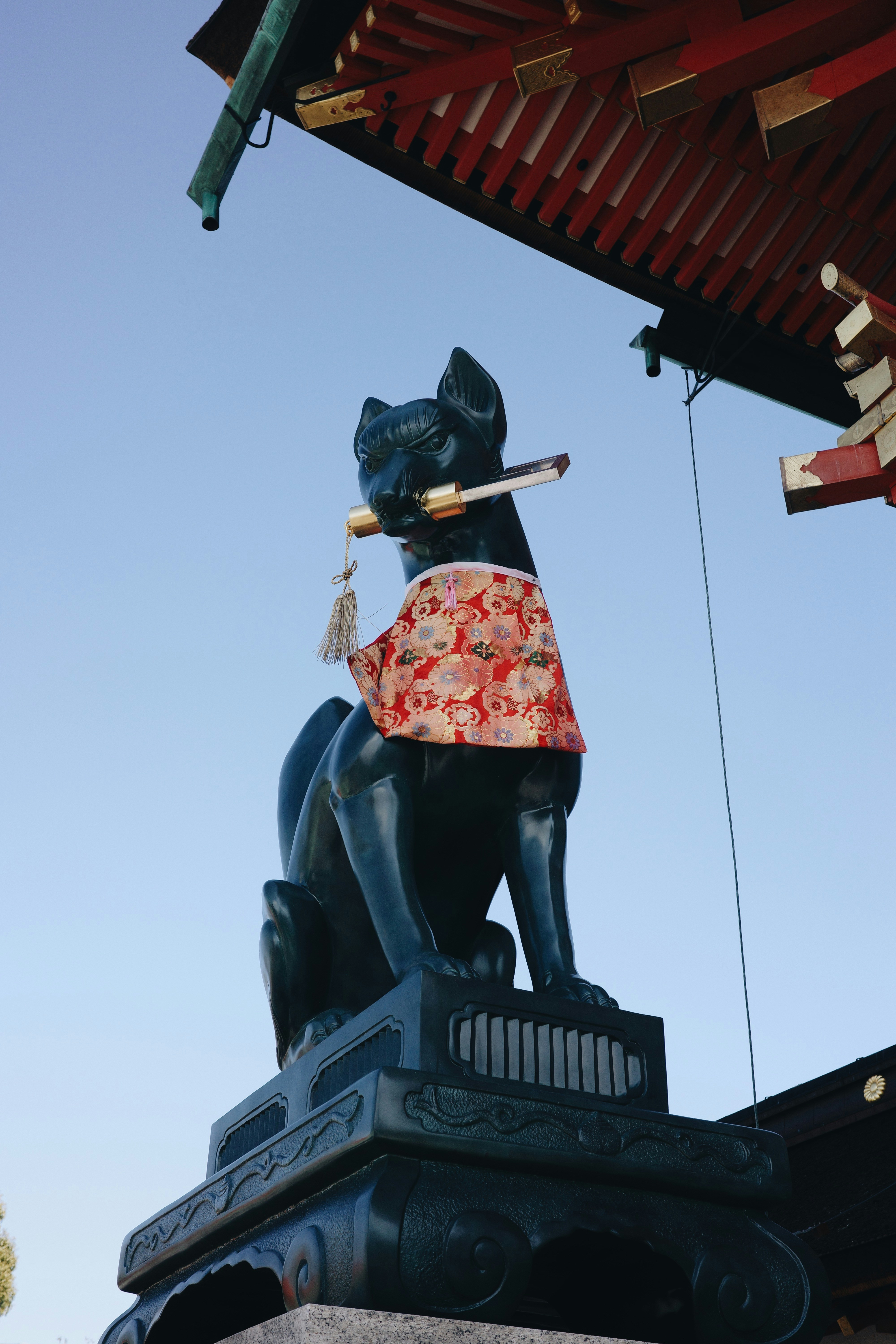 Noble guardian in ceremonial garb stands watch under a temple eave