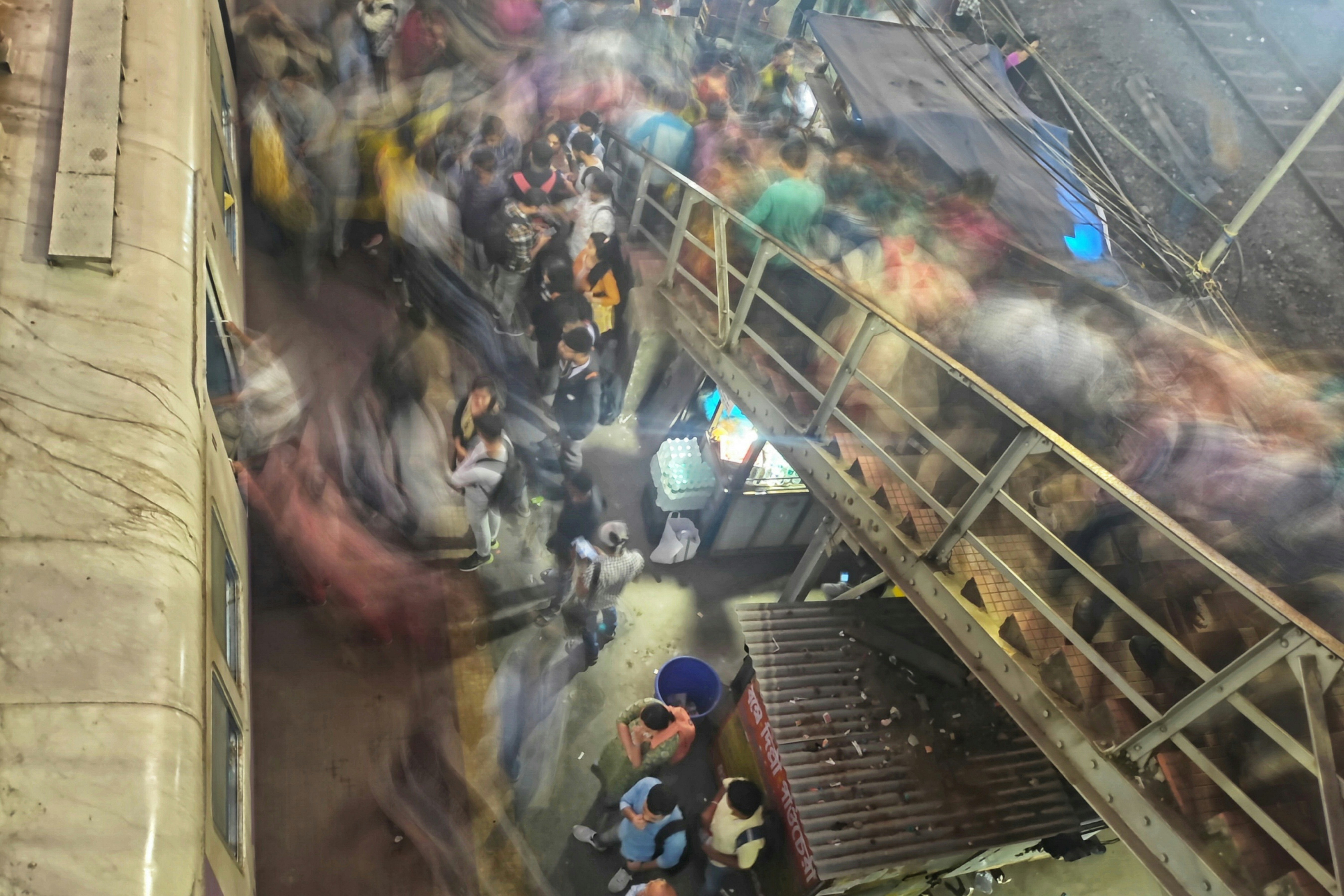 A crowd of people standing on top of a train platform