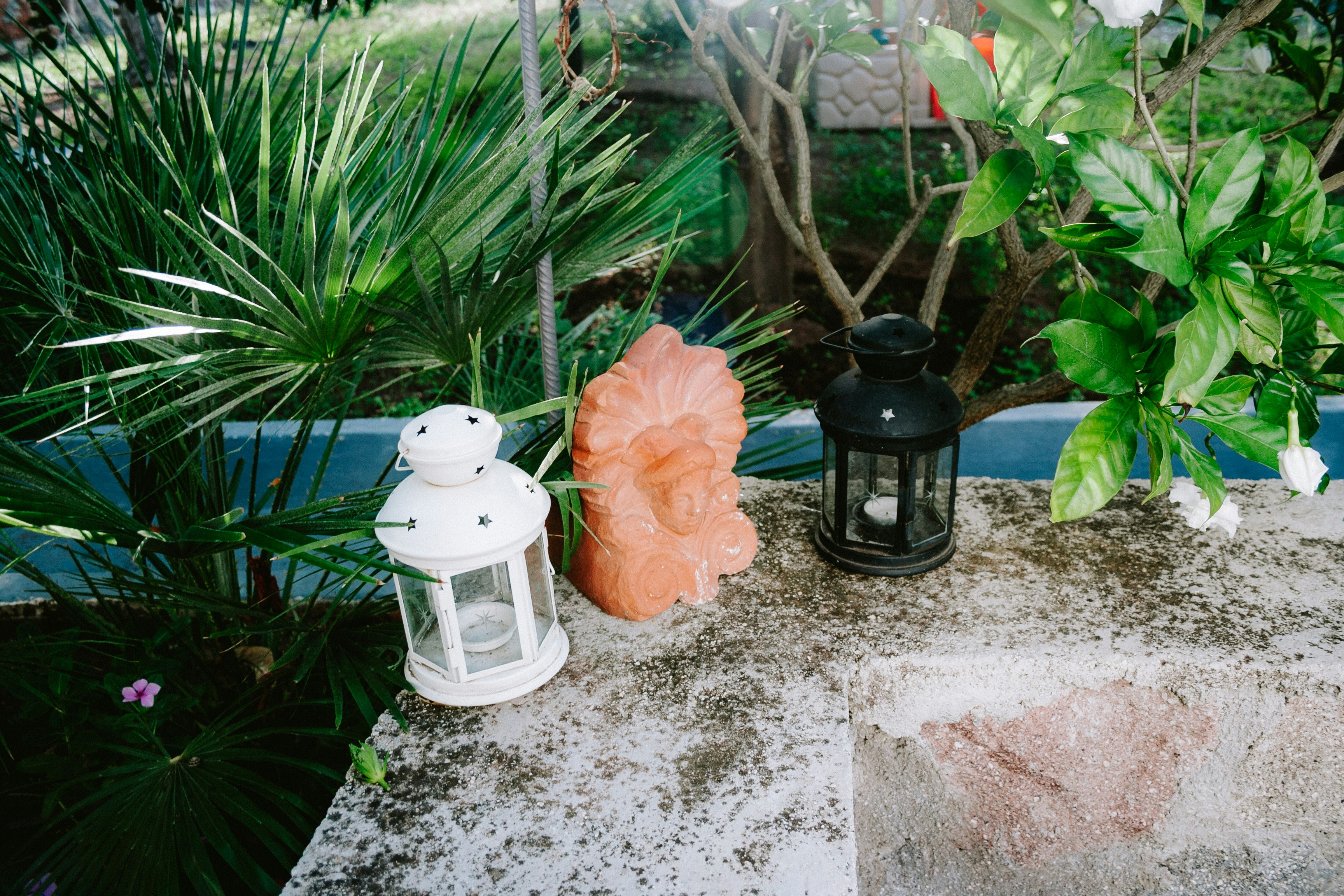 Whimsical Lantern Trio on a Rustic Ledge