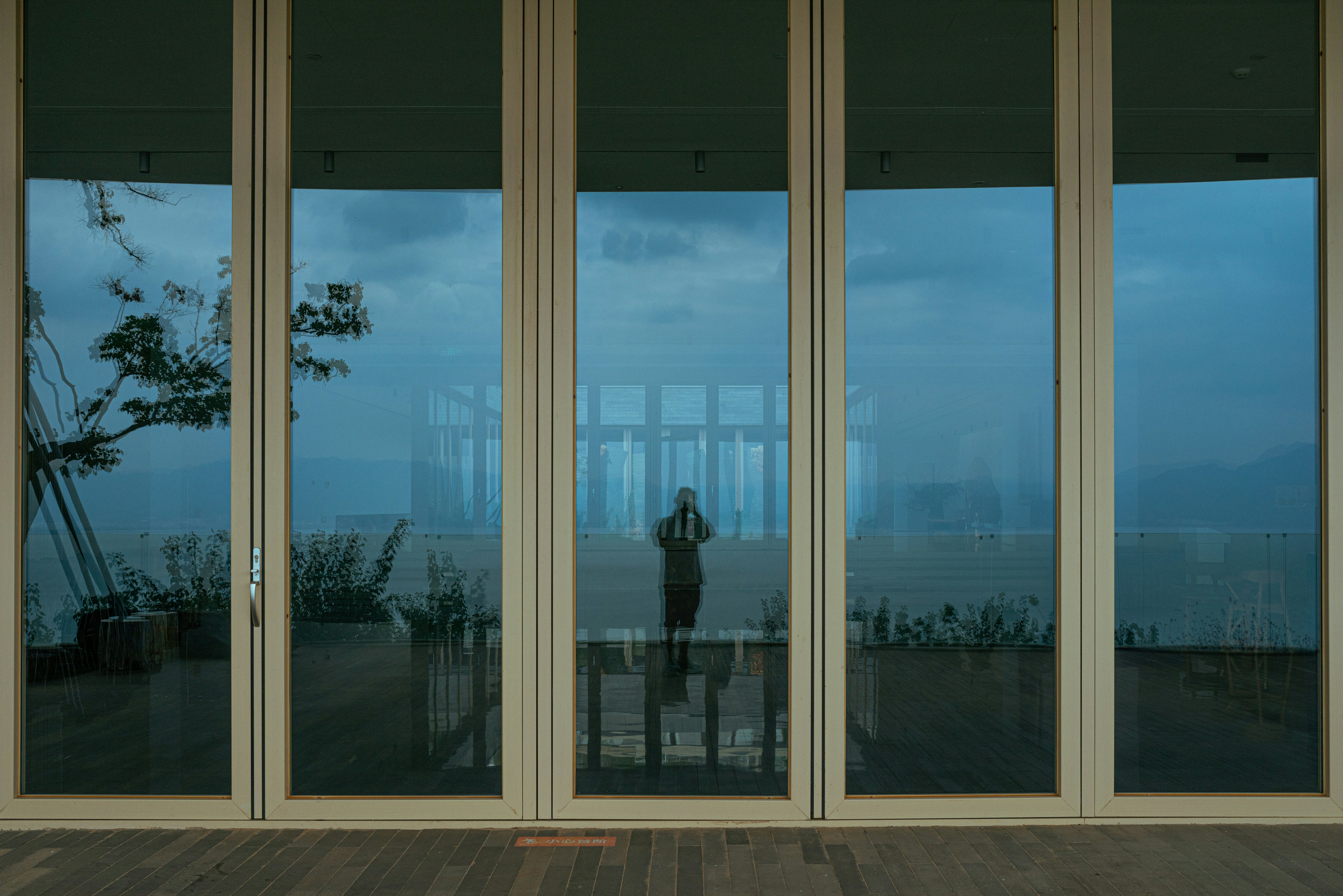 A person standing in front of a large window photo – Free Door Image on ...