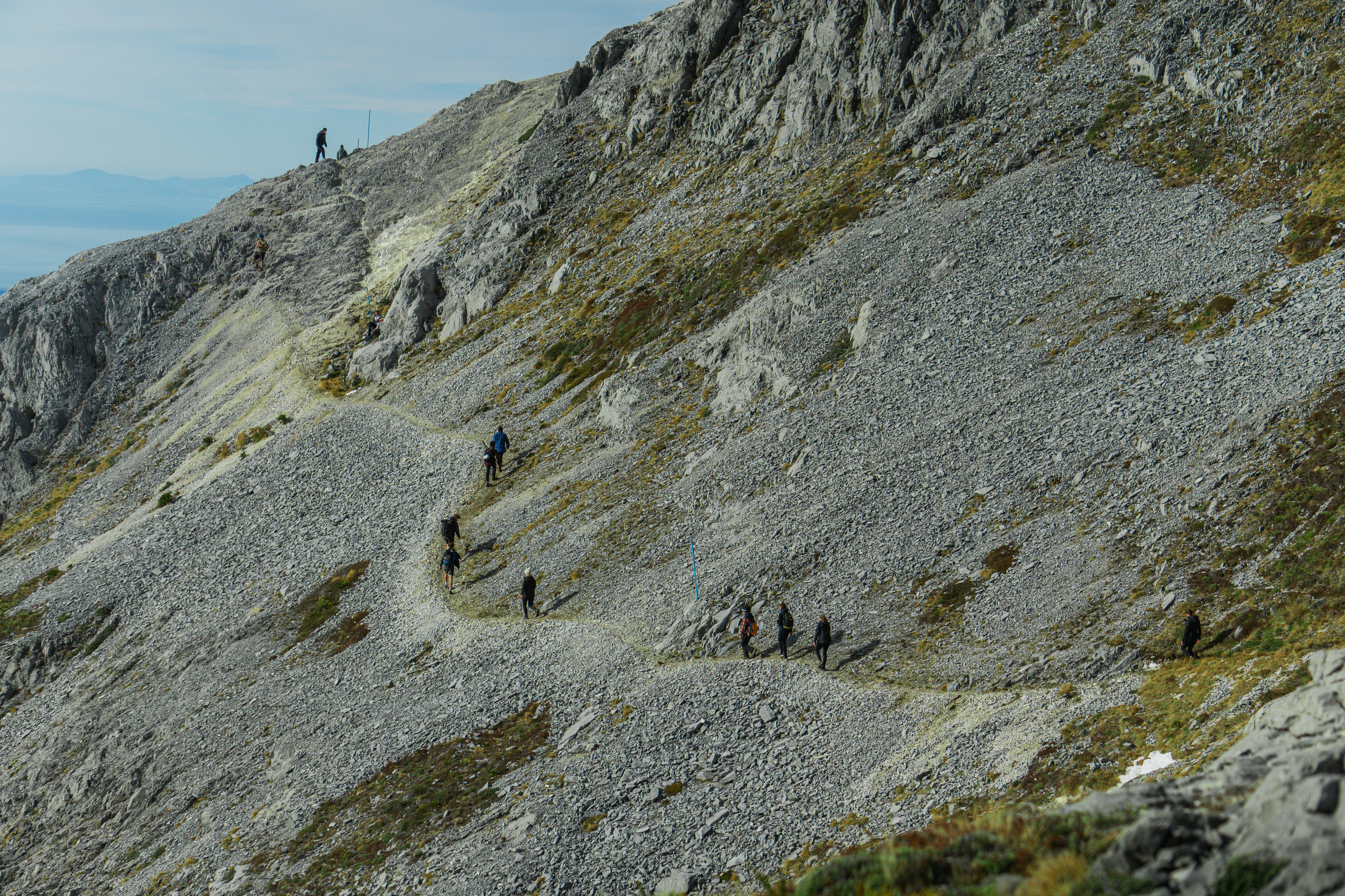 Un groupe de personnes faisant de la randonnée sur le flanc d’une ...
