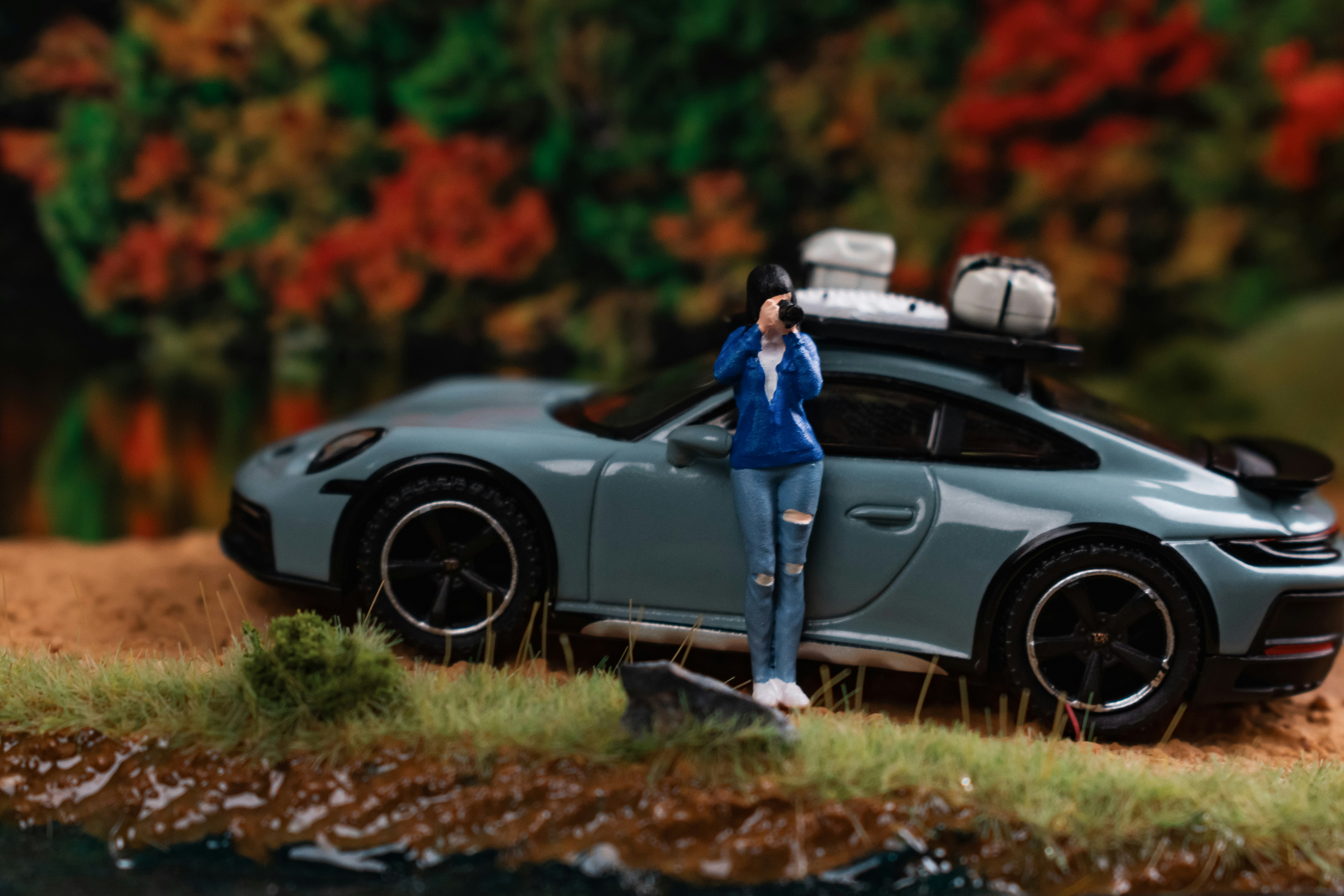 A model of a car with a person taking a picture photo – Free Moreart ...