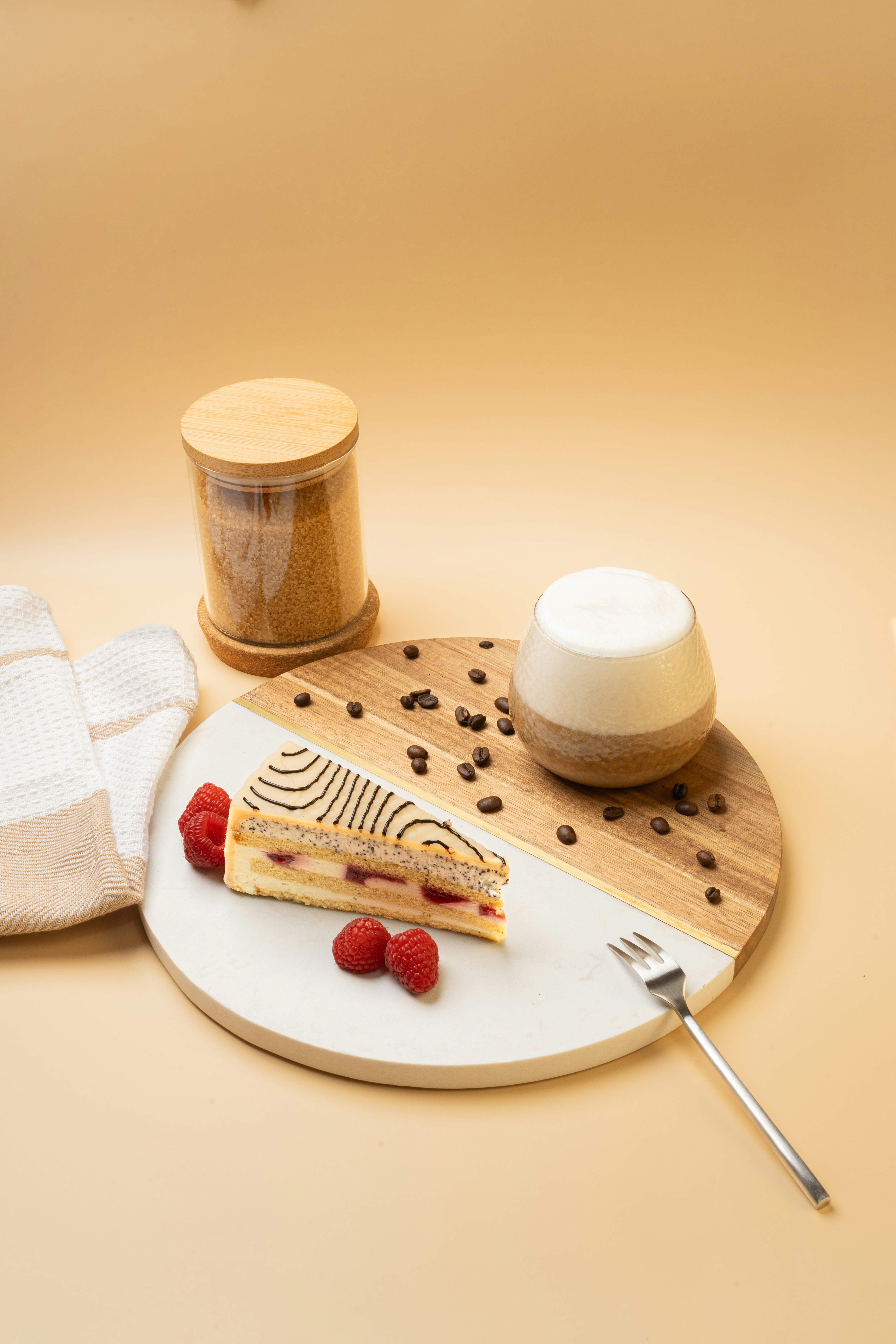 Layered Berry Cream Cake on a Marble Board, Paired with a Frothy Latte