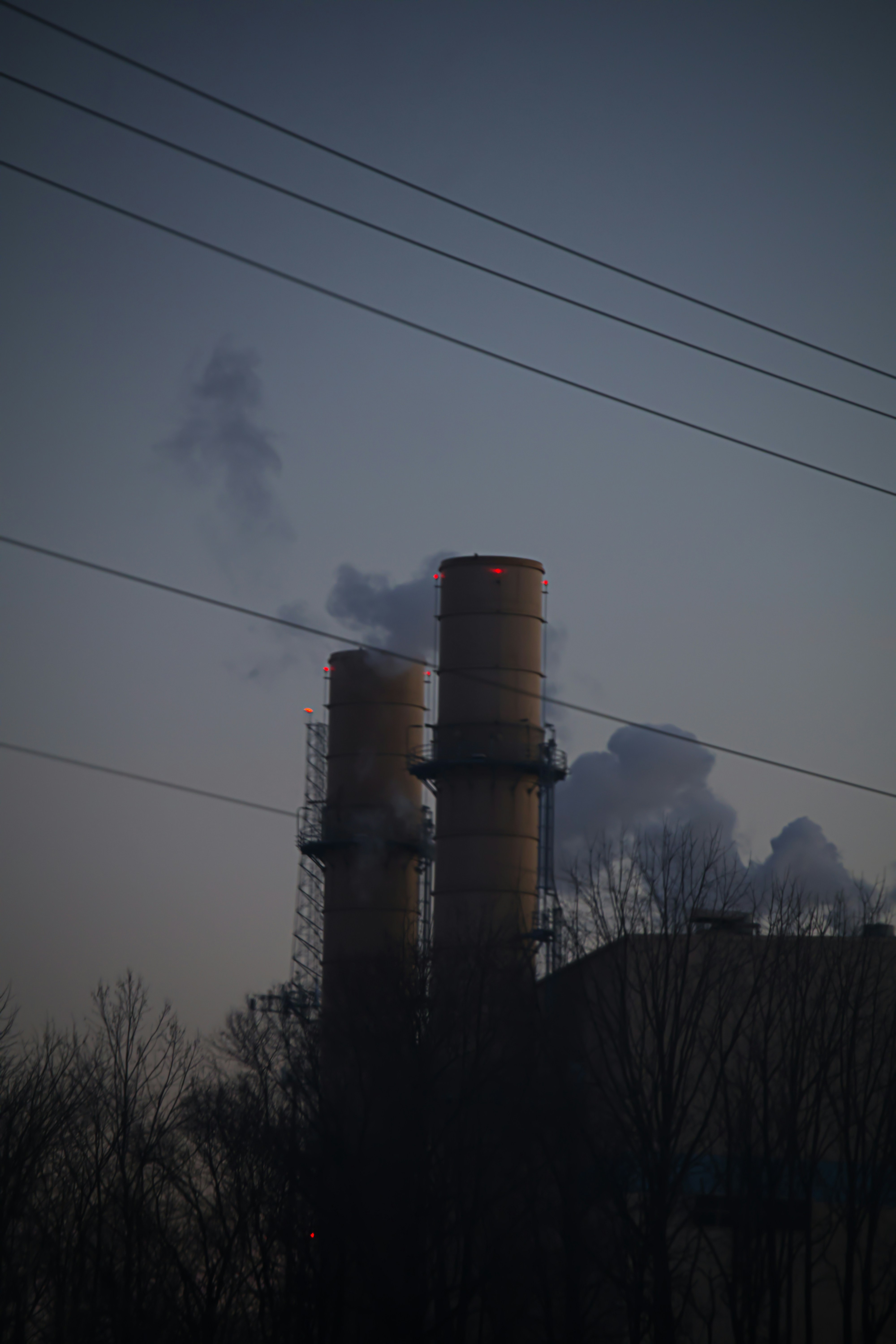 Twilight Over Twin Smokestacks: Steam Trails and Quiet Wires