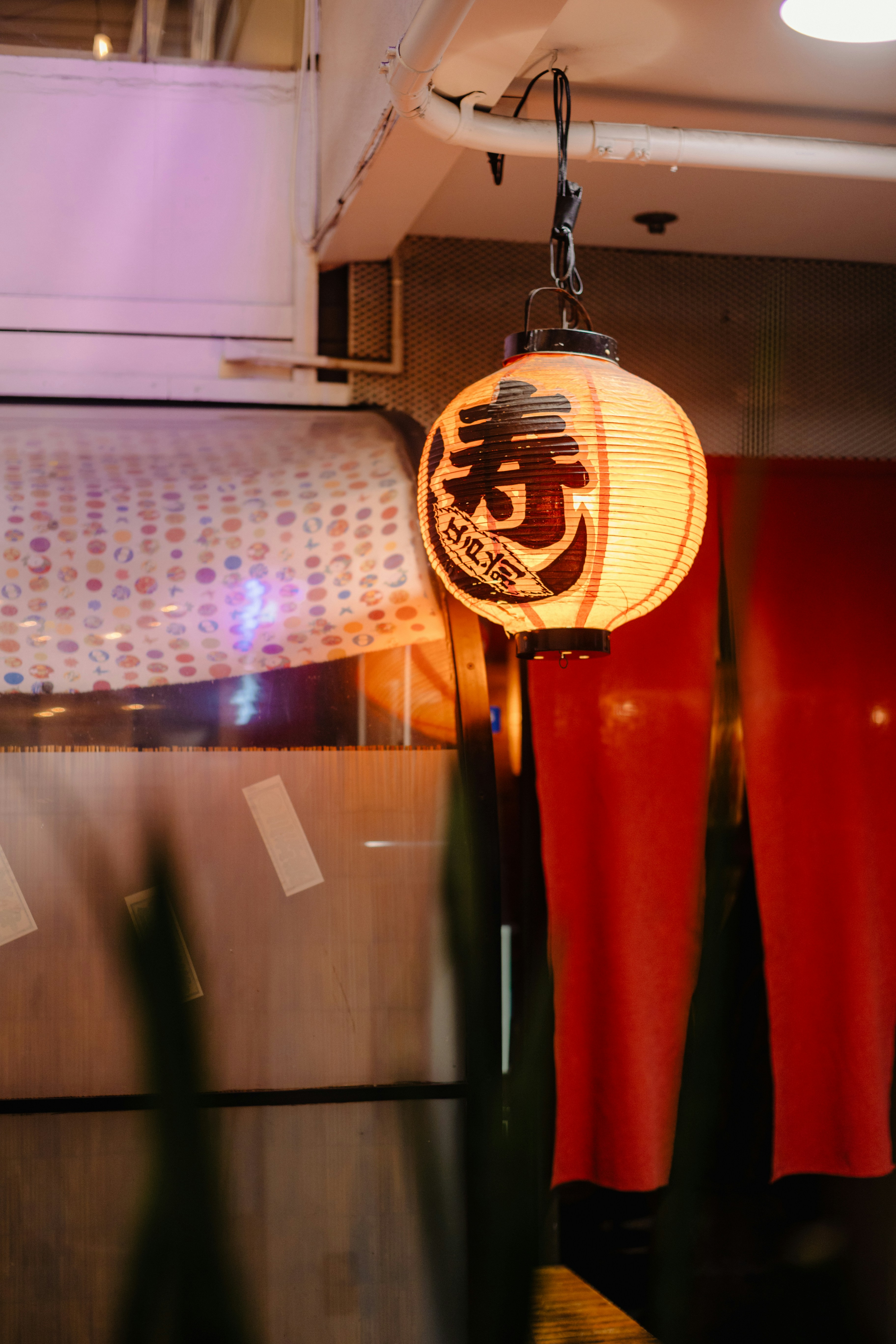 Lantern Glow Above a Red Curtain
