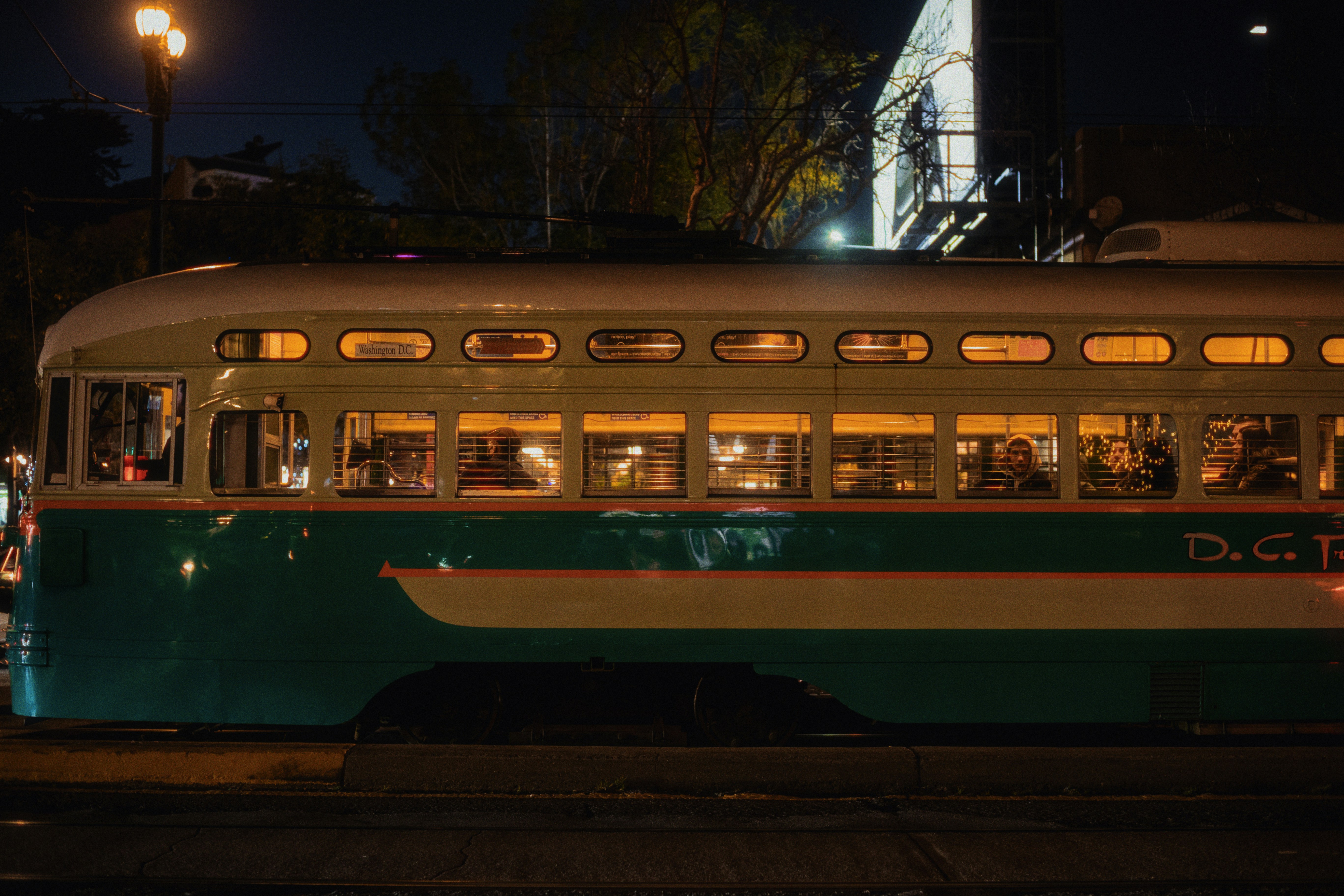 A green and white bus on street at night photo – Free Rail Image on ...