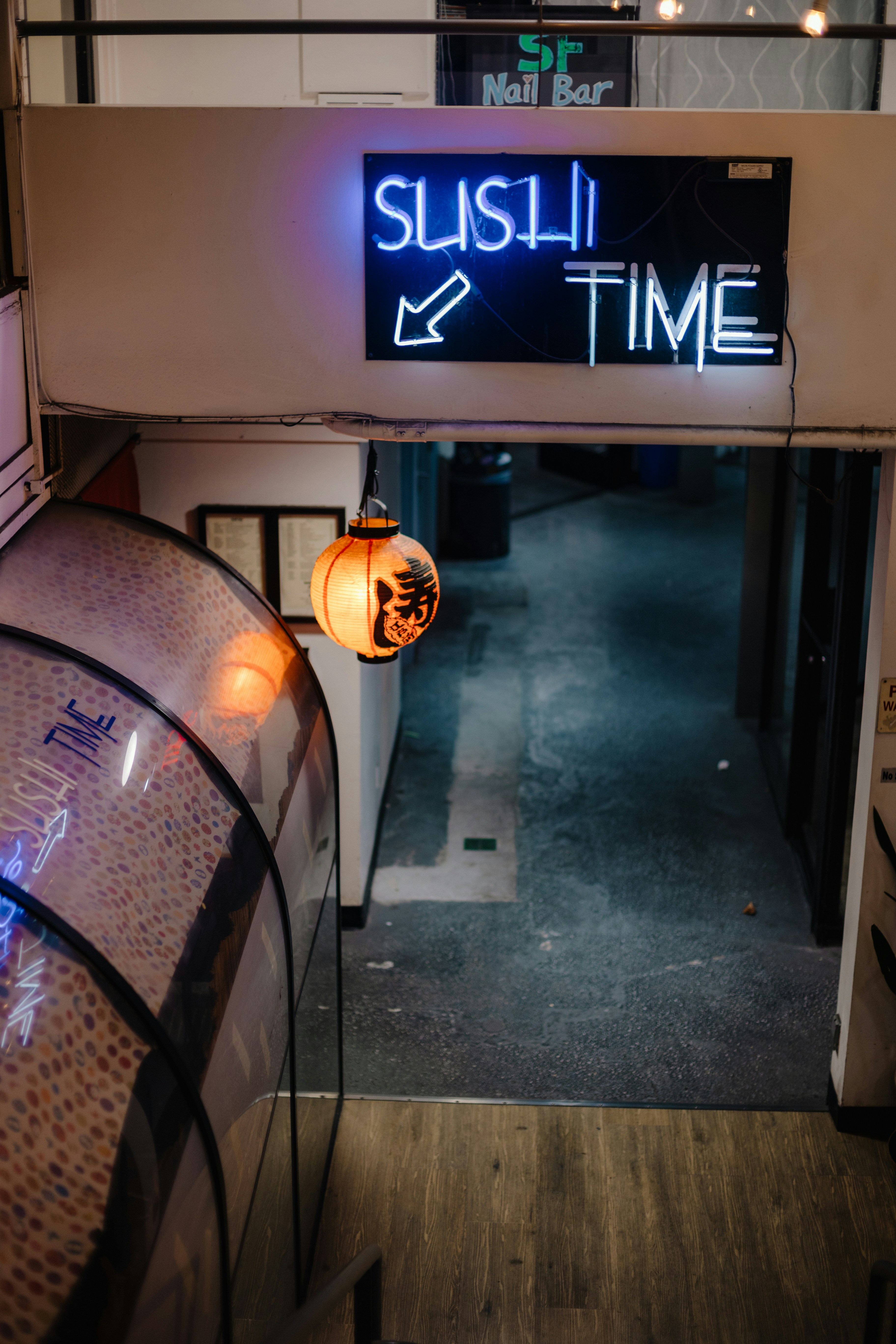 Neon SUSHI TIME Over a Dim Corridor