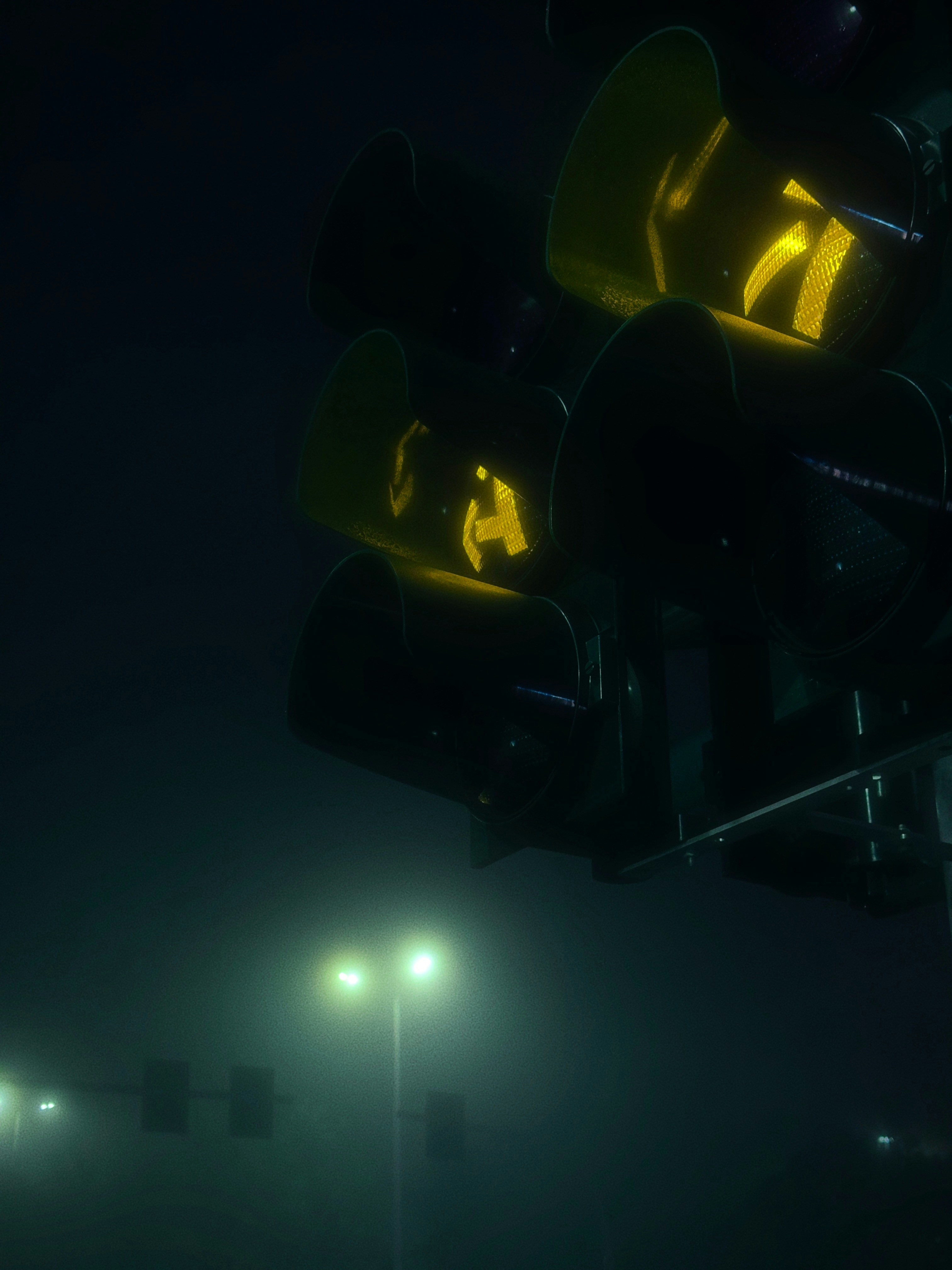 A traffic light hanging over a street at night photo – Free Light Image ...