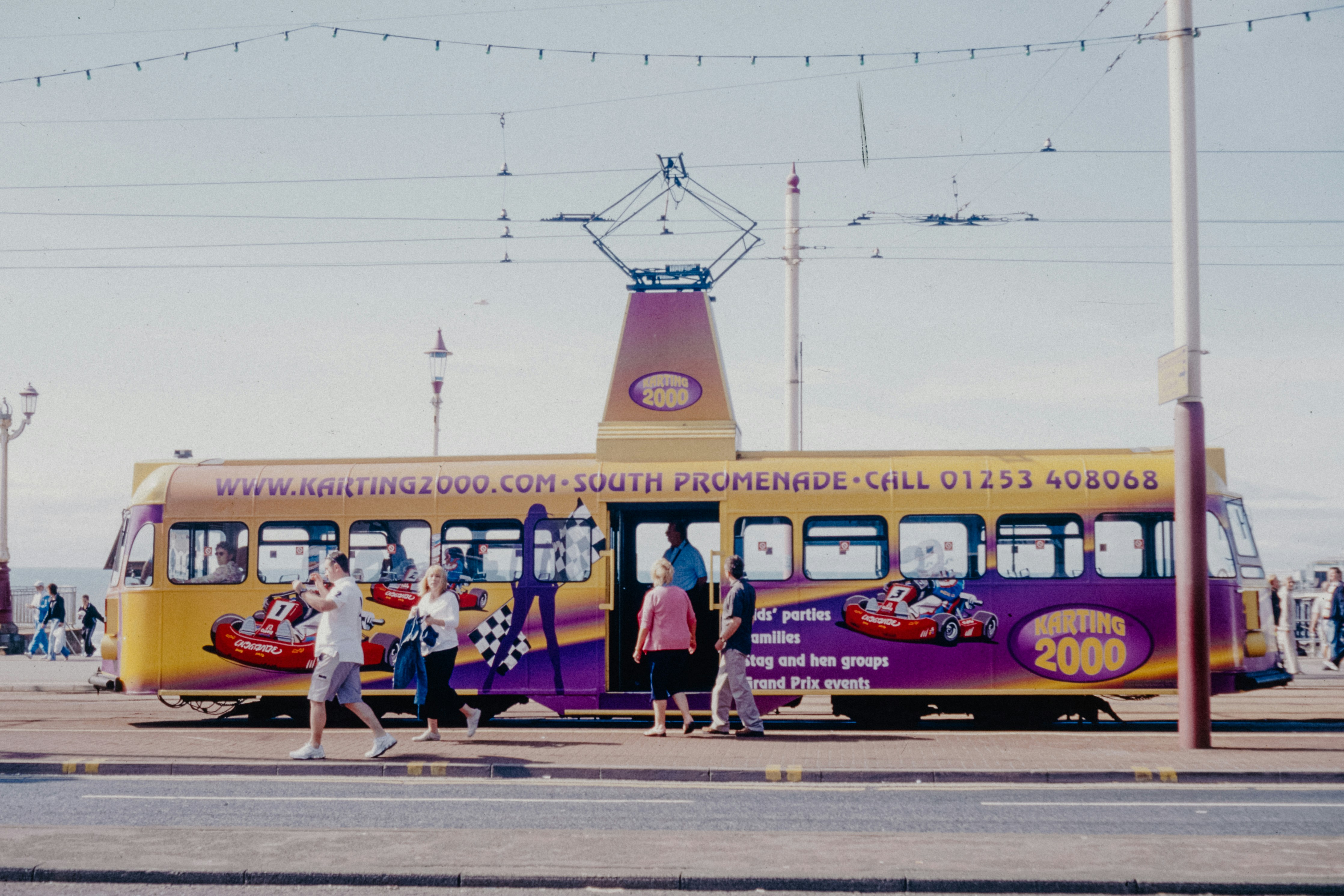 A yellow and purple trolley on a city street photo – Free Blackpool ...