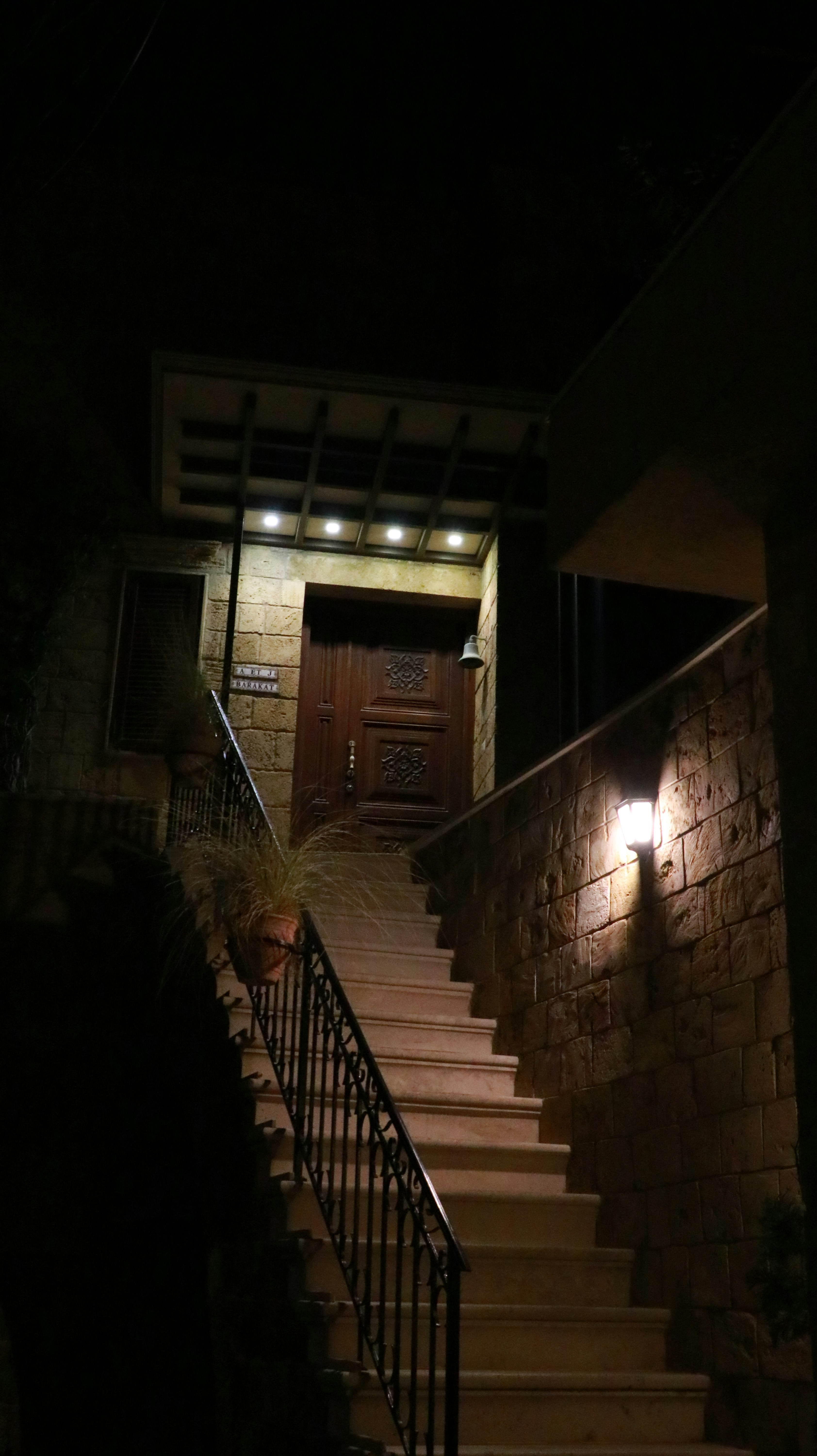 A staircase leading up to a door at night photo – Free Building Image ...