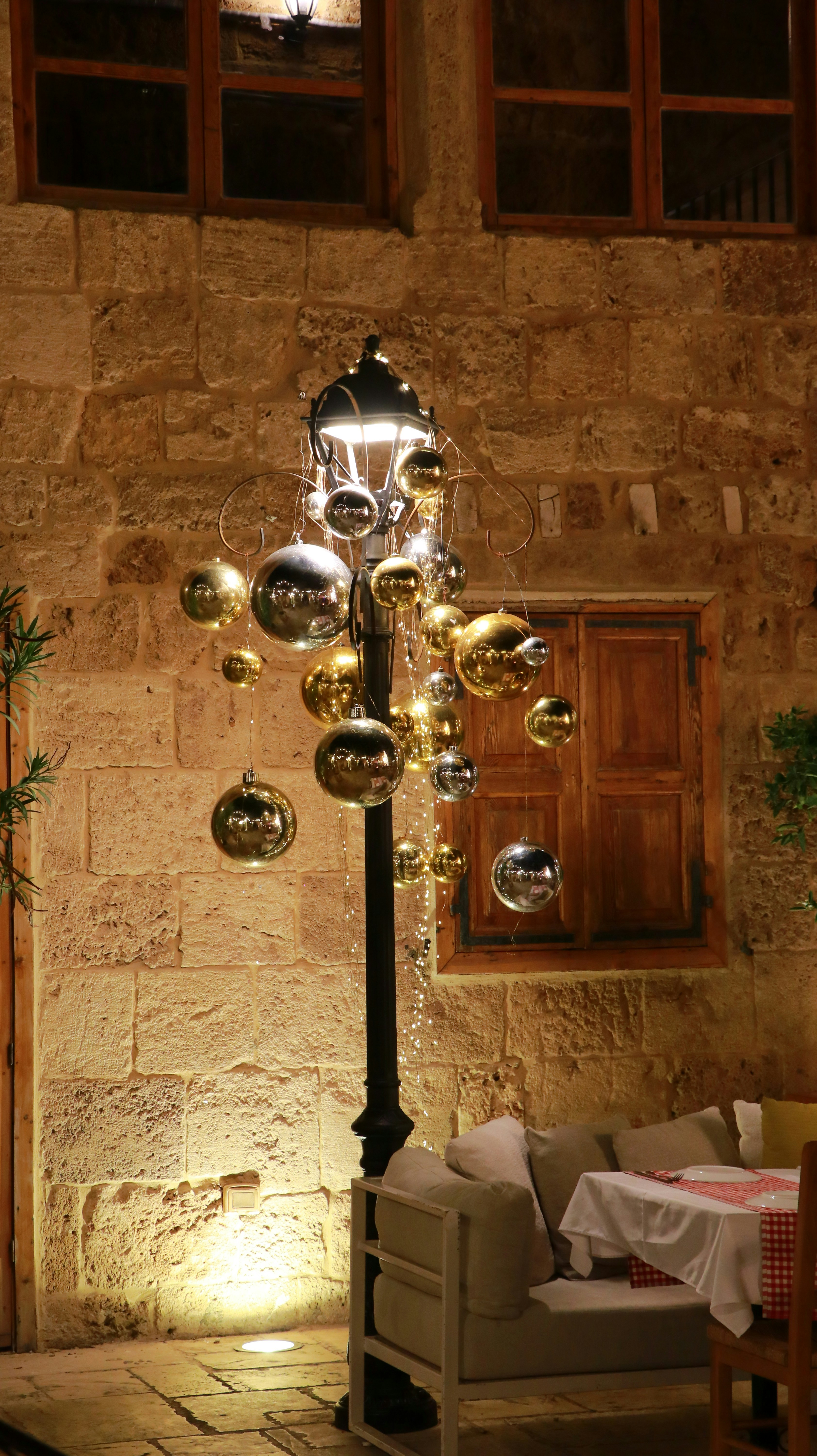 Ornate Orbs Swing from a Stone Courtyard Lantern