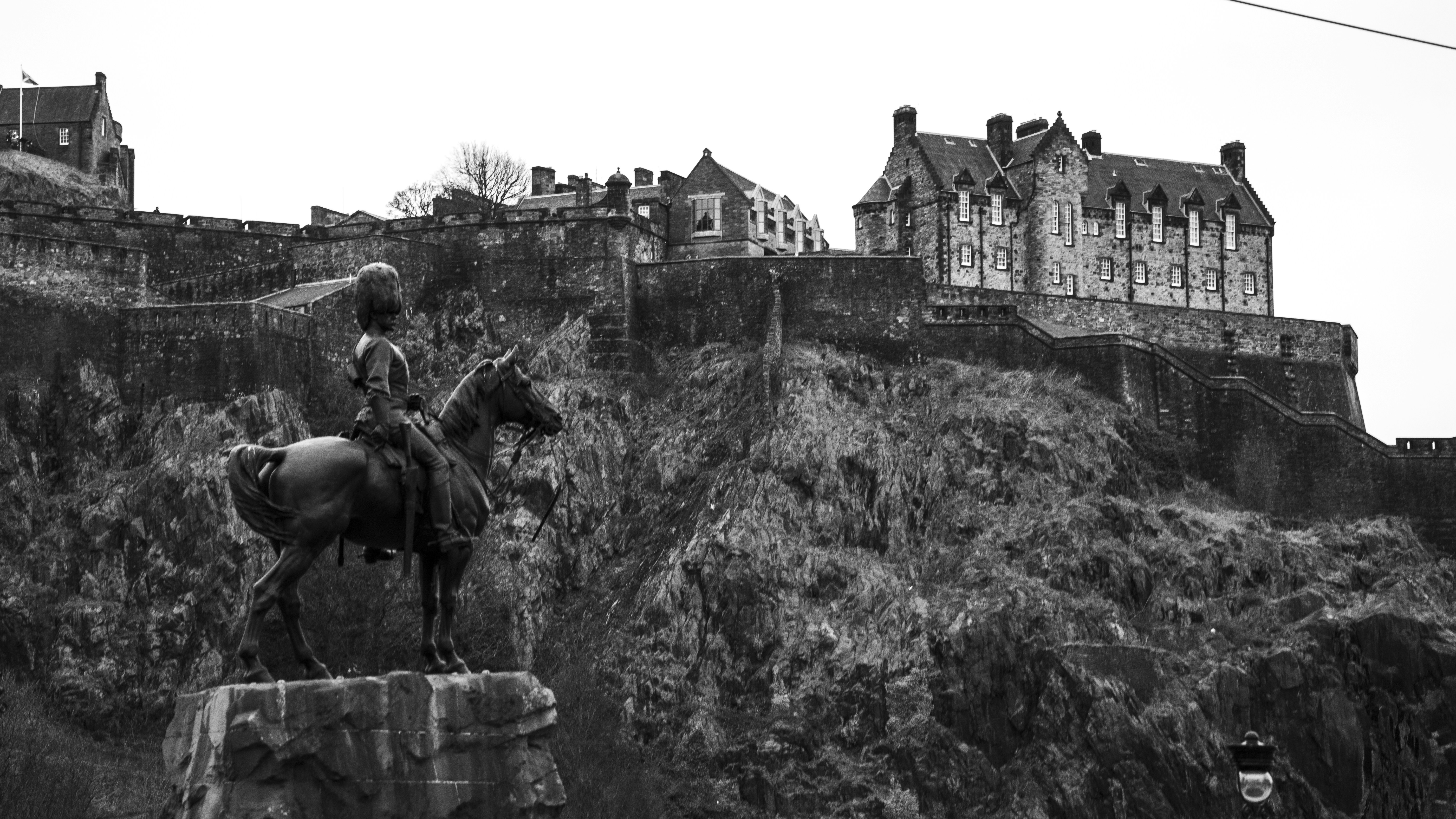 Sentinel on Stone: A Horse Statue Overlooking a Clifftop Fortress