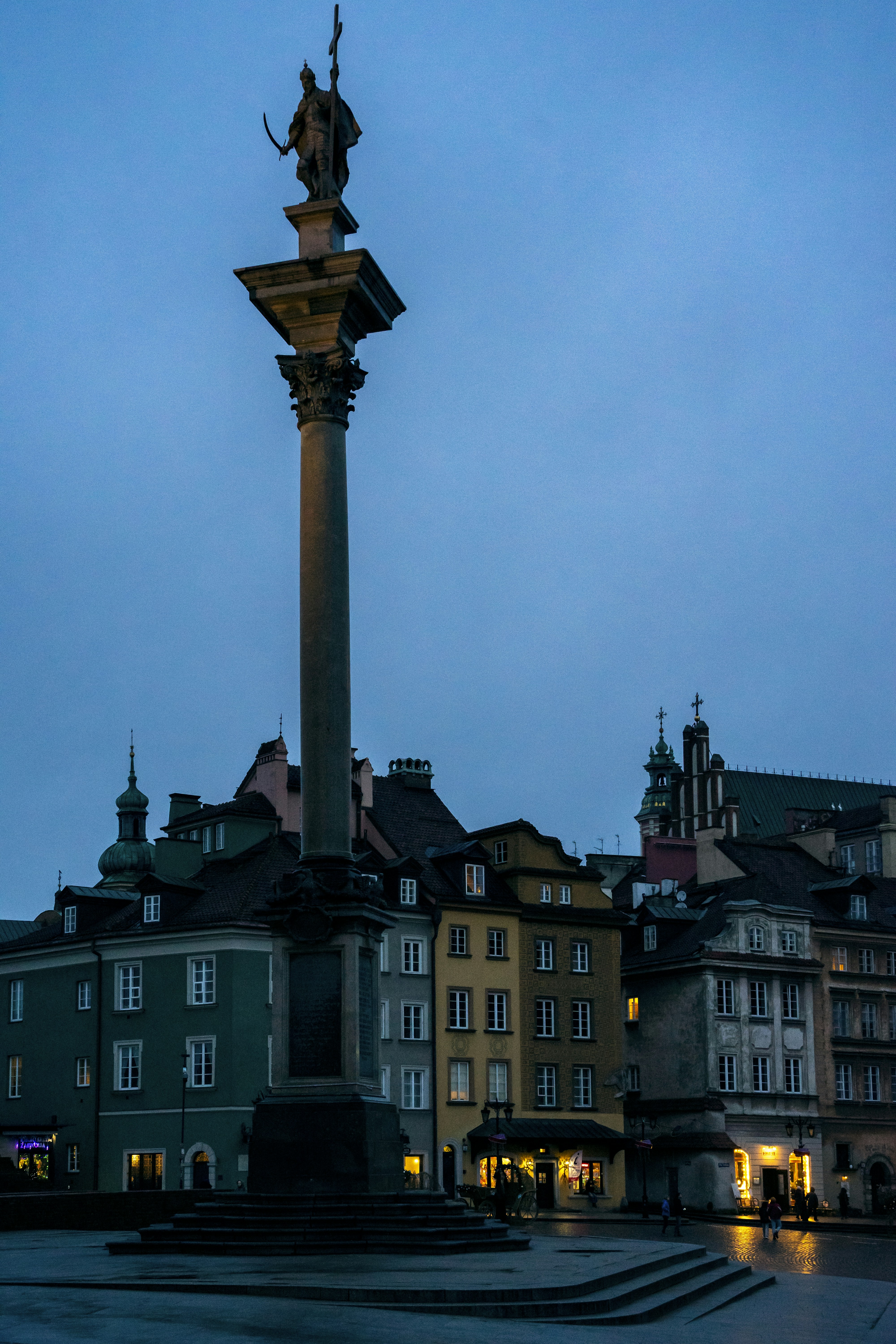 A tall clock tower sitting in the middle of a city