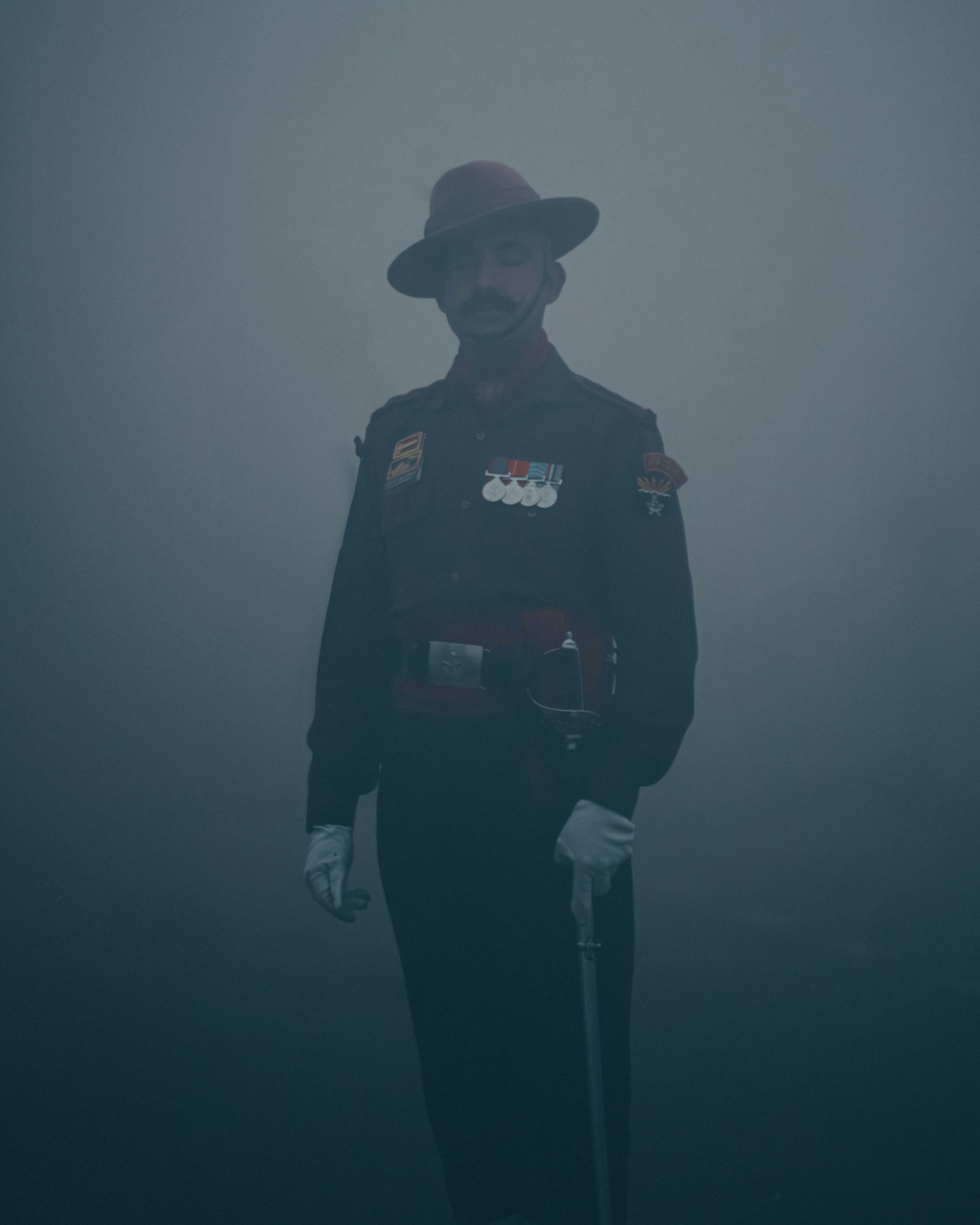 Whispered Valor: A ceremonial officer emerges through the fog