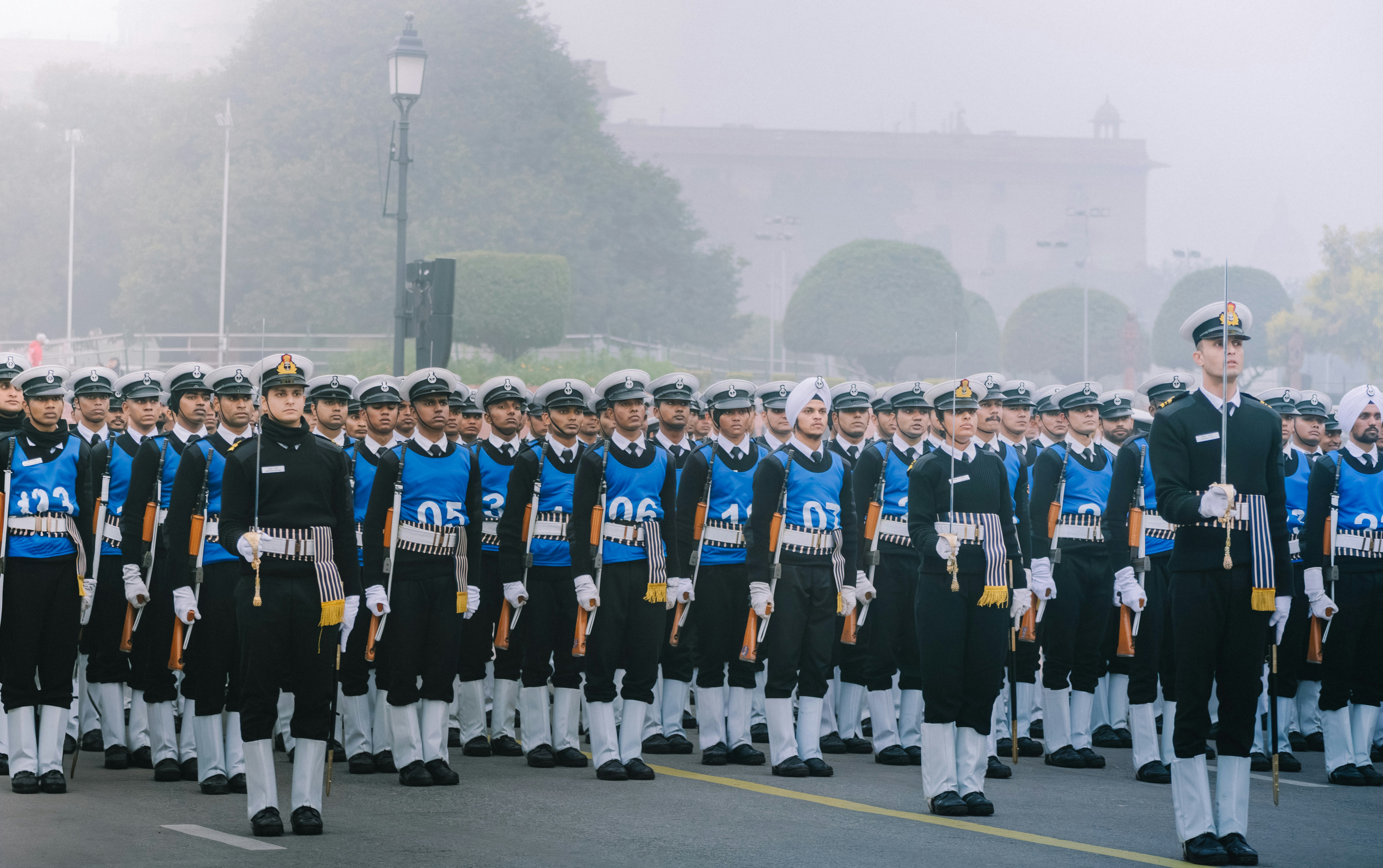 A group of men in uniform marching down a street photo – Free Army ...