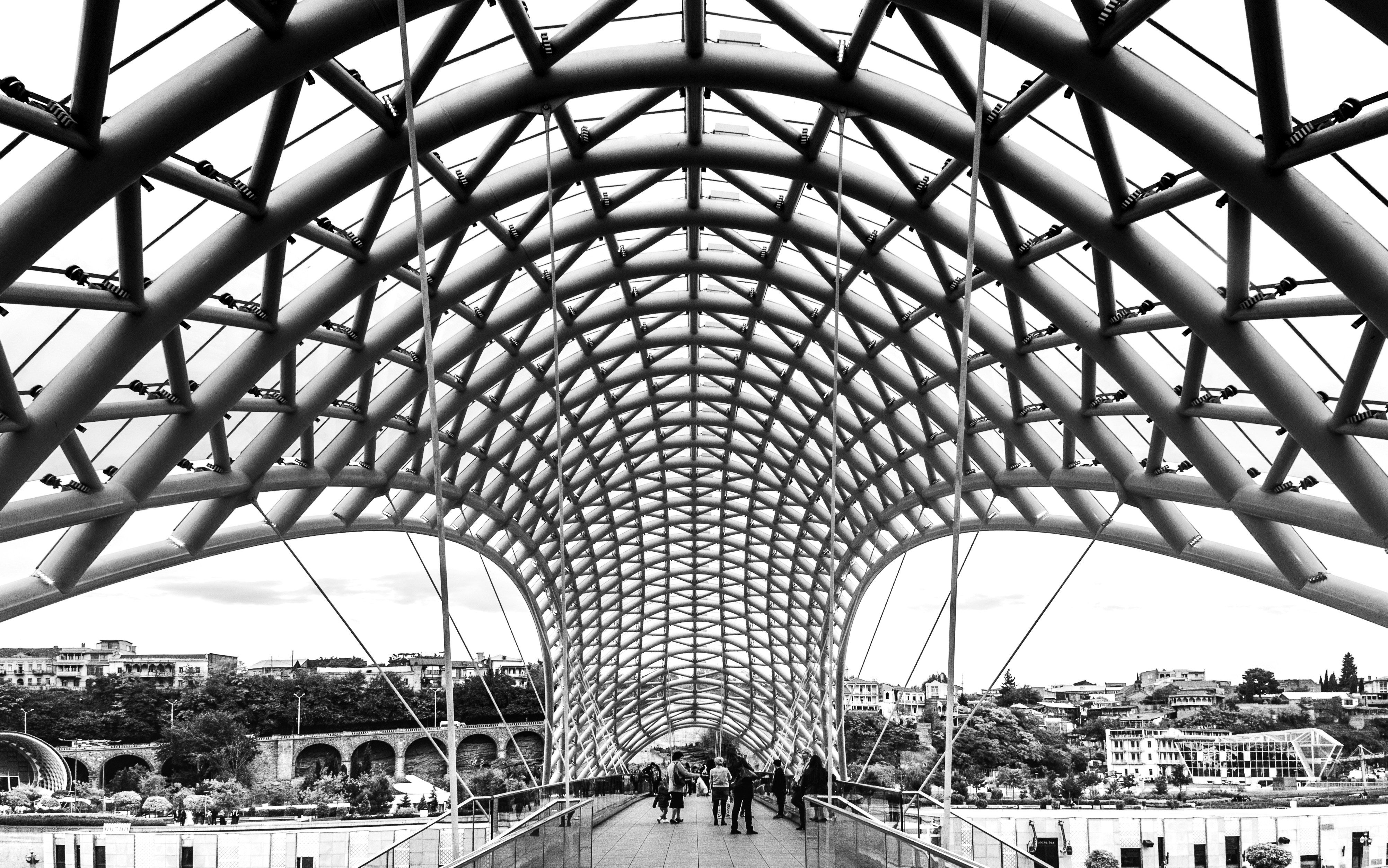 Architectural bridge structure with intricate geometric patterns in monochrome.