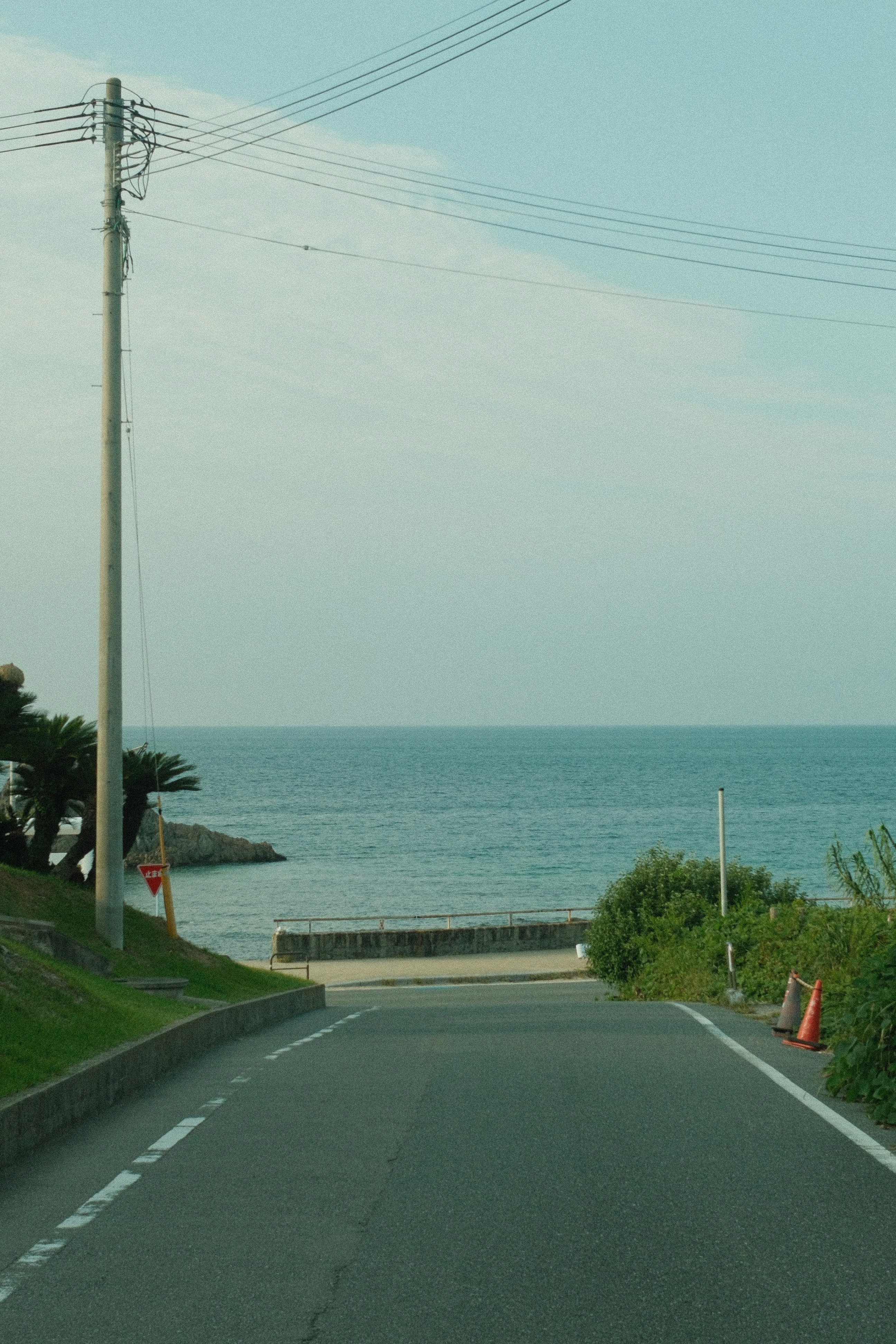 Vanishing Coastal Road Toward the Sea