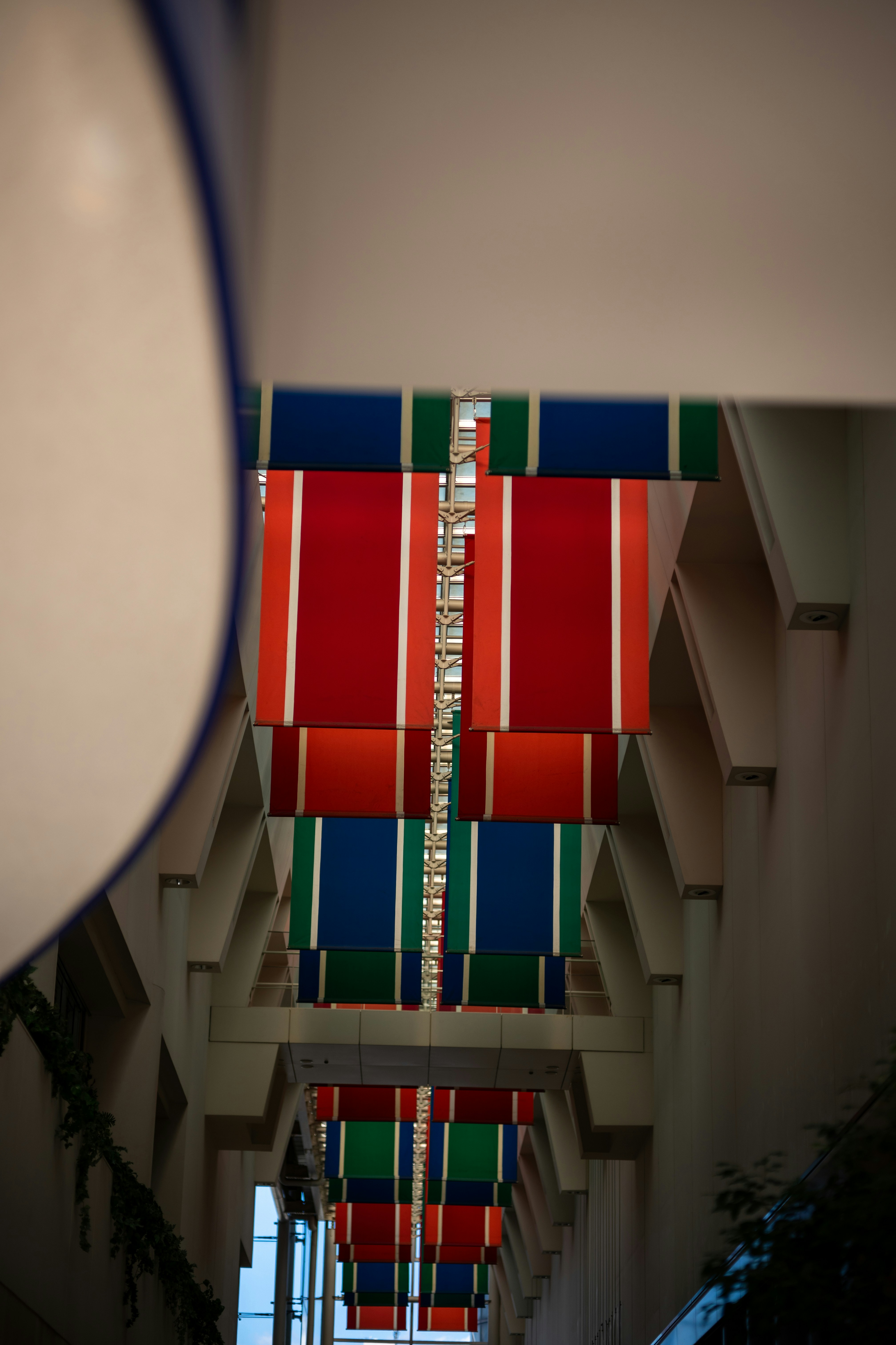 Vertical Symphony of Color: Banners Align the Corridor Ceiling