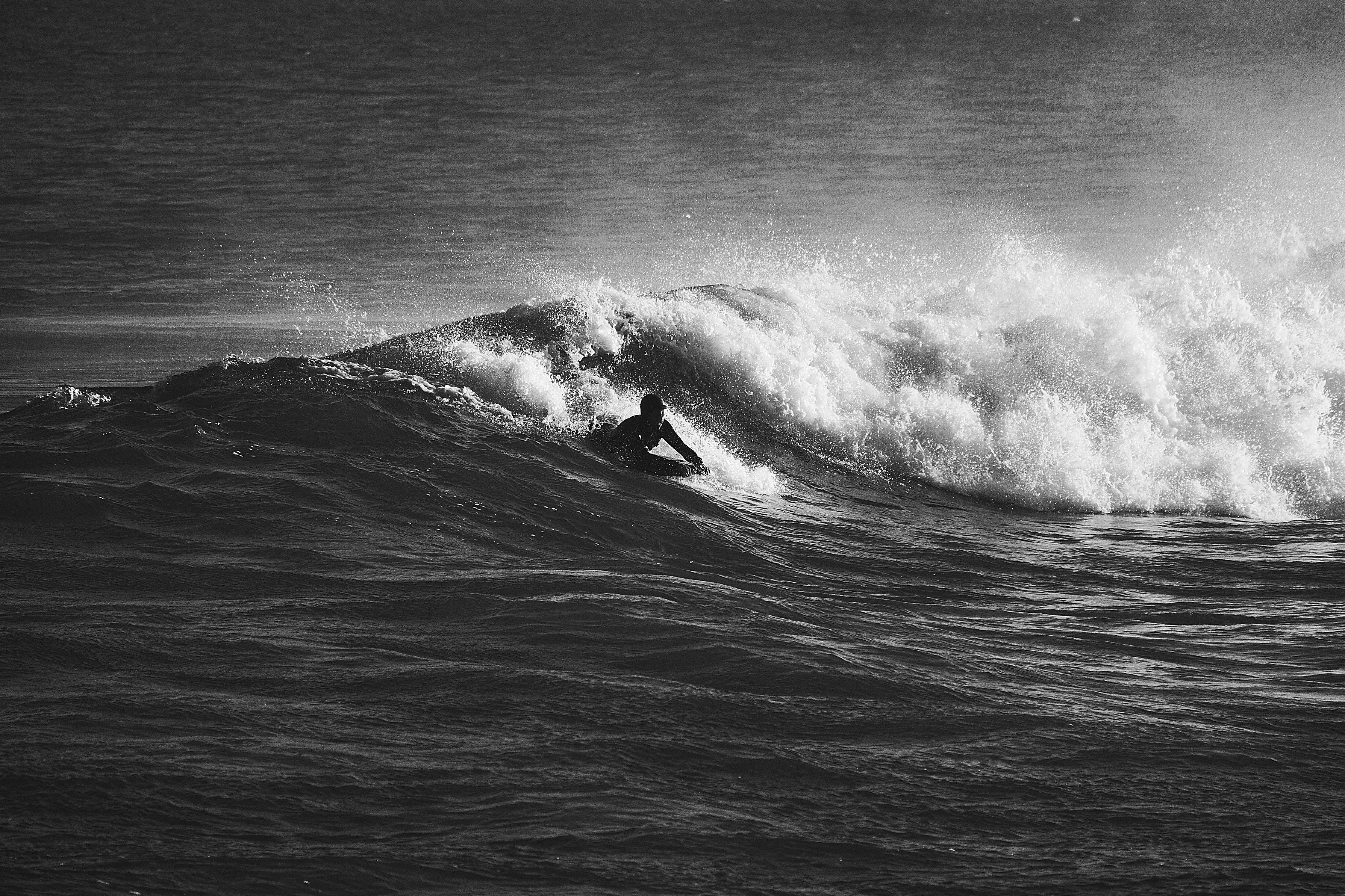 A man riding a wave on top of a surfboard photo – Free Nature Image on ...