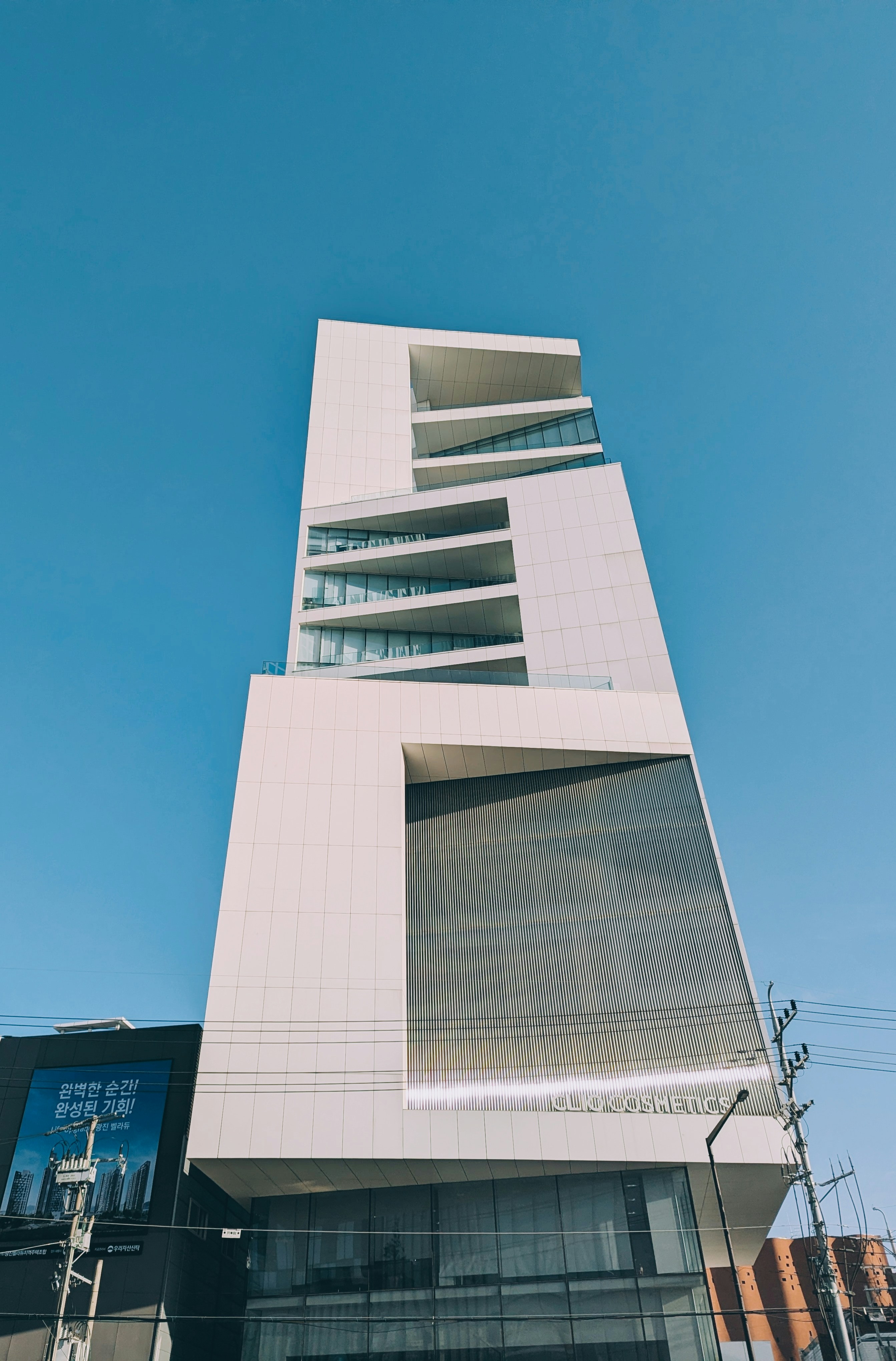 Stacked Silence: A White Tower Pierces the Sky