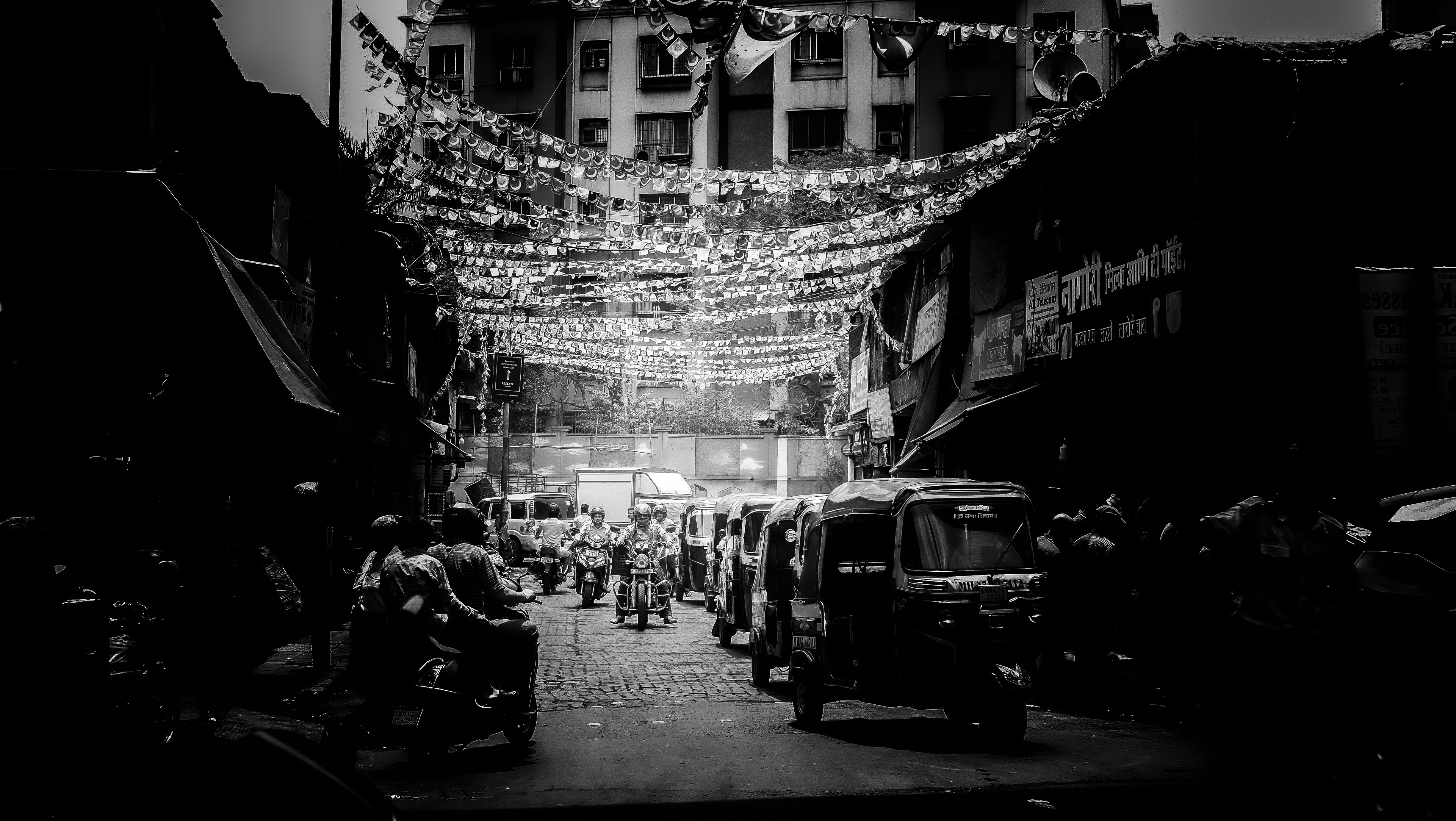Threads of Light Over a Crowded Night Market Street
