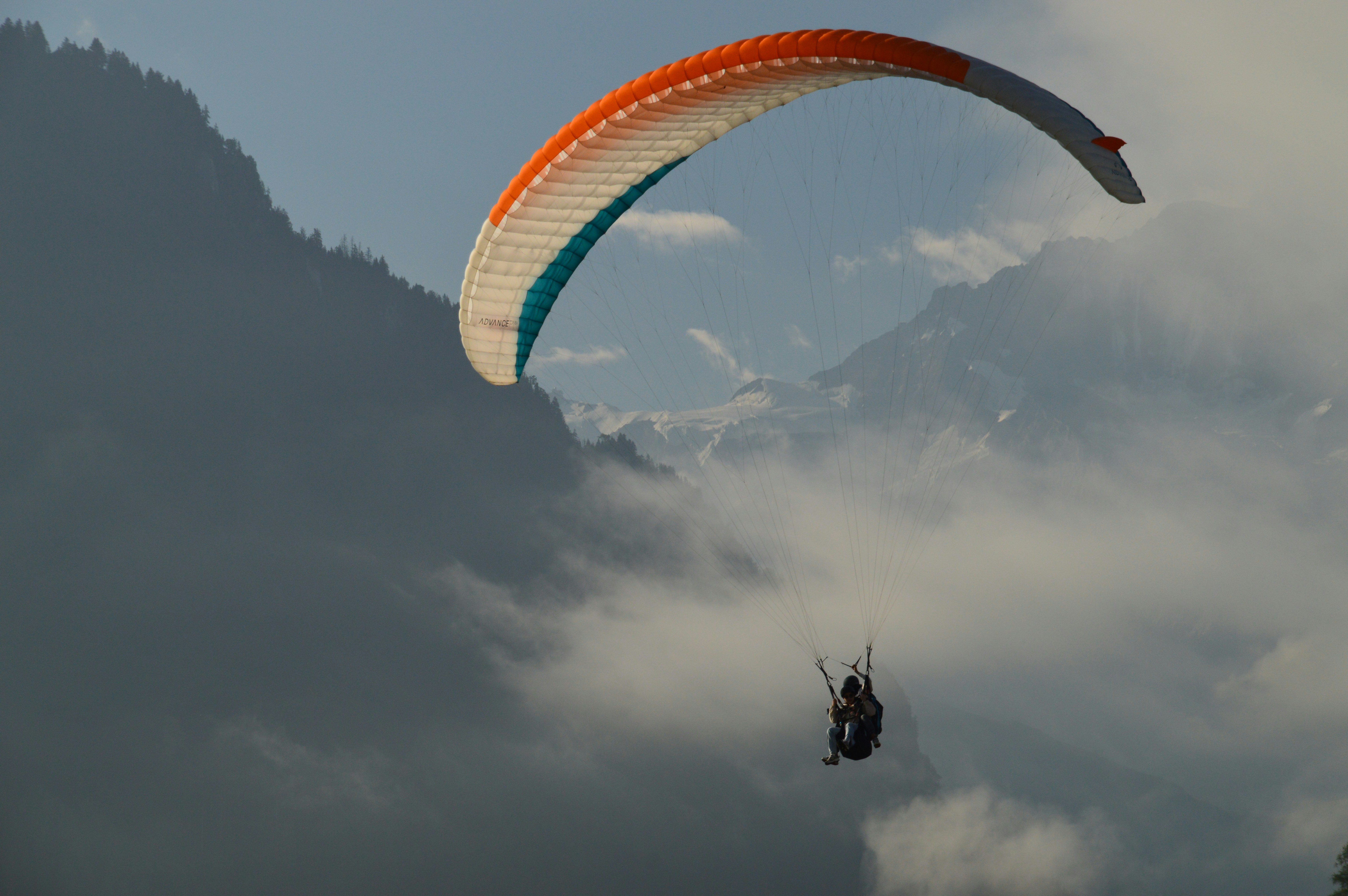 Alpine Paraglider Pierces a Sea of Clouds