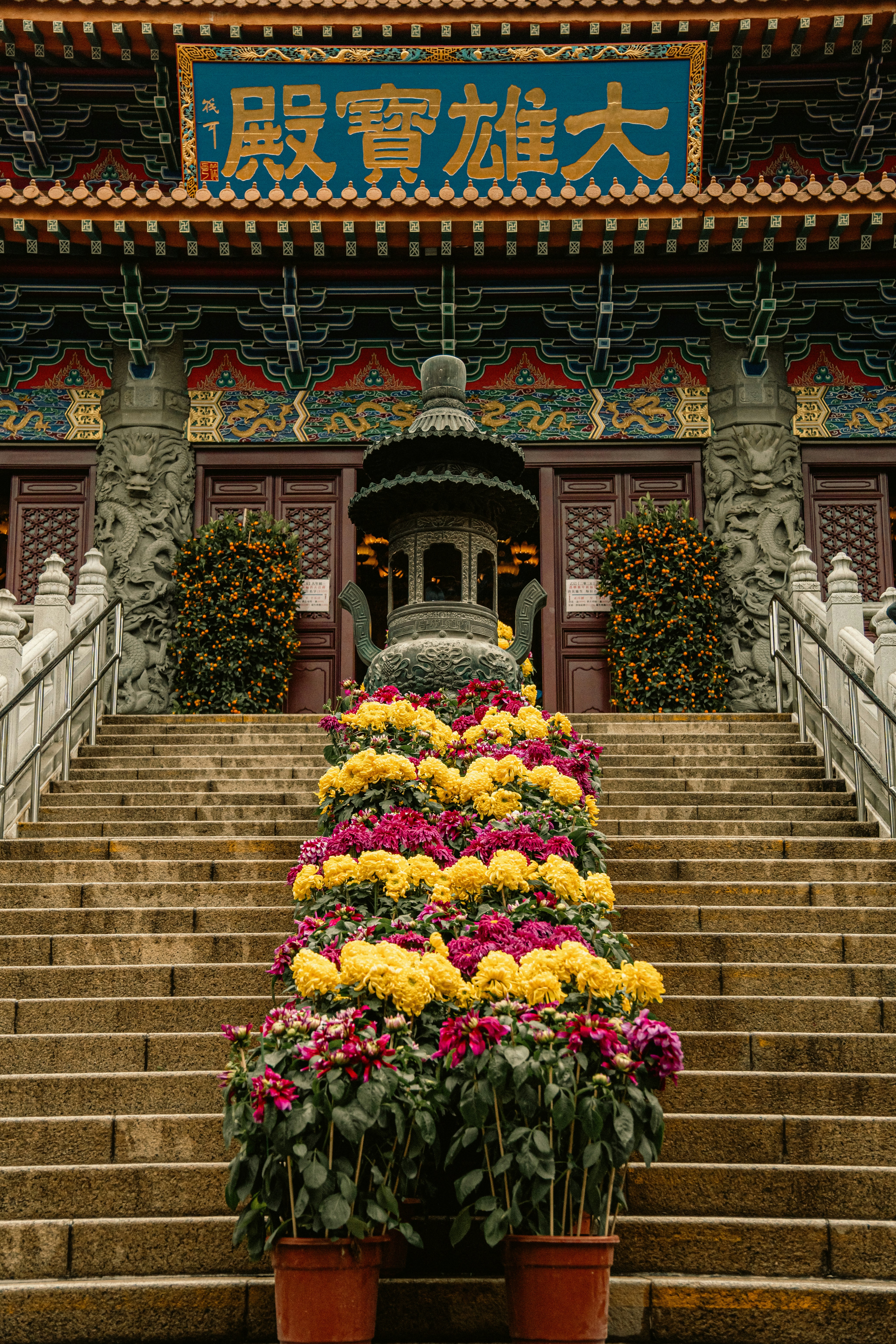Ceremonial Lantern Rising Over a Staircase Framed by Colorful Chrysanthemums