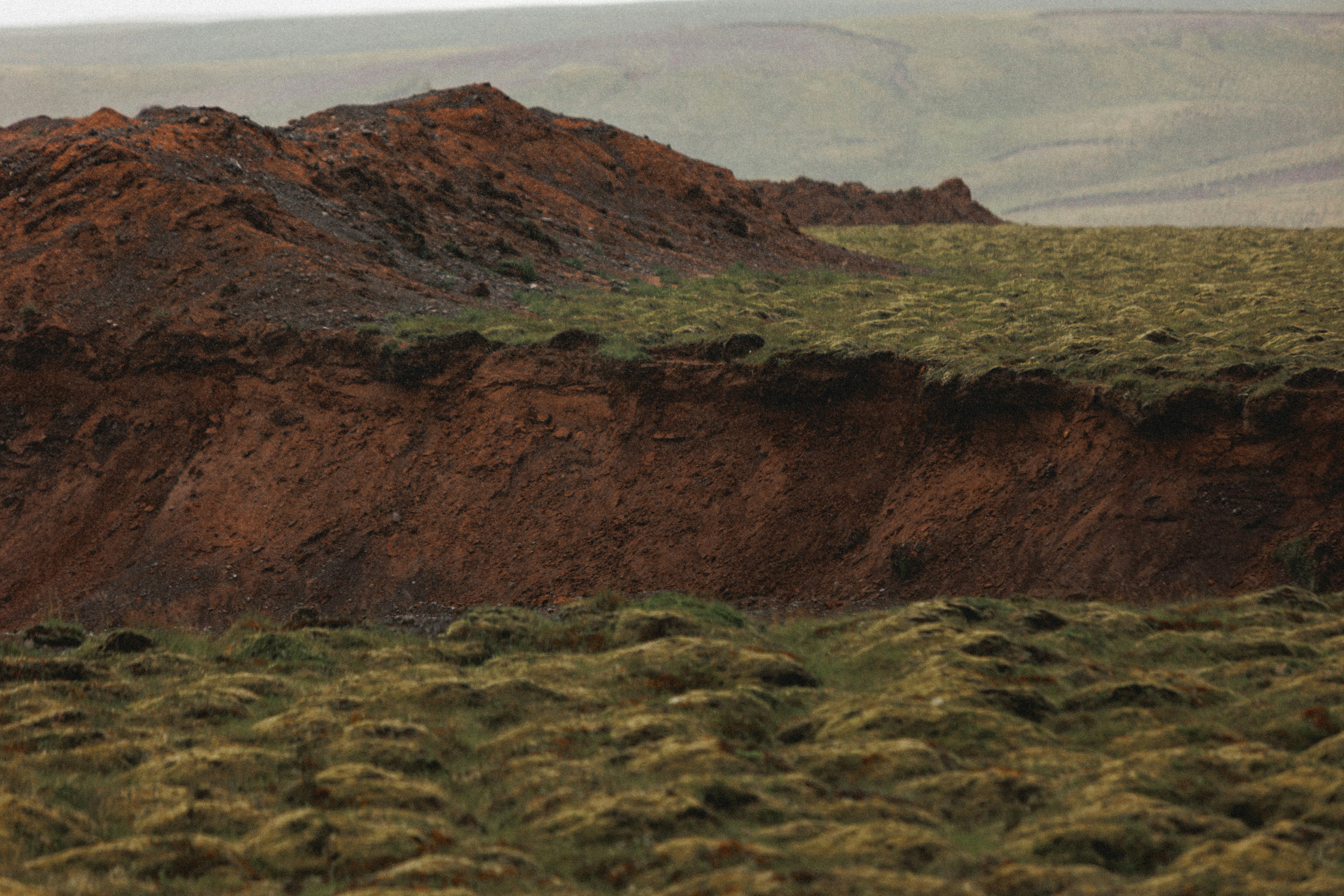 A large hill with grass growing on top of it photo – Free Land Image on ...