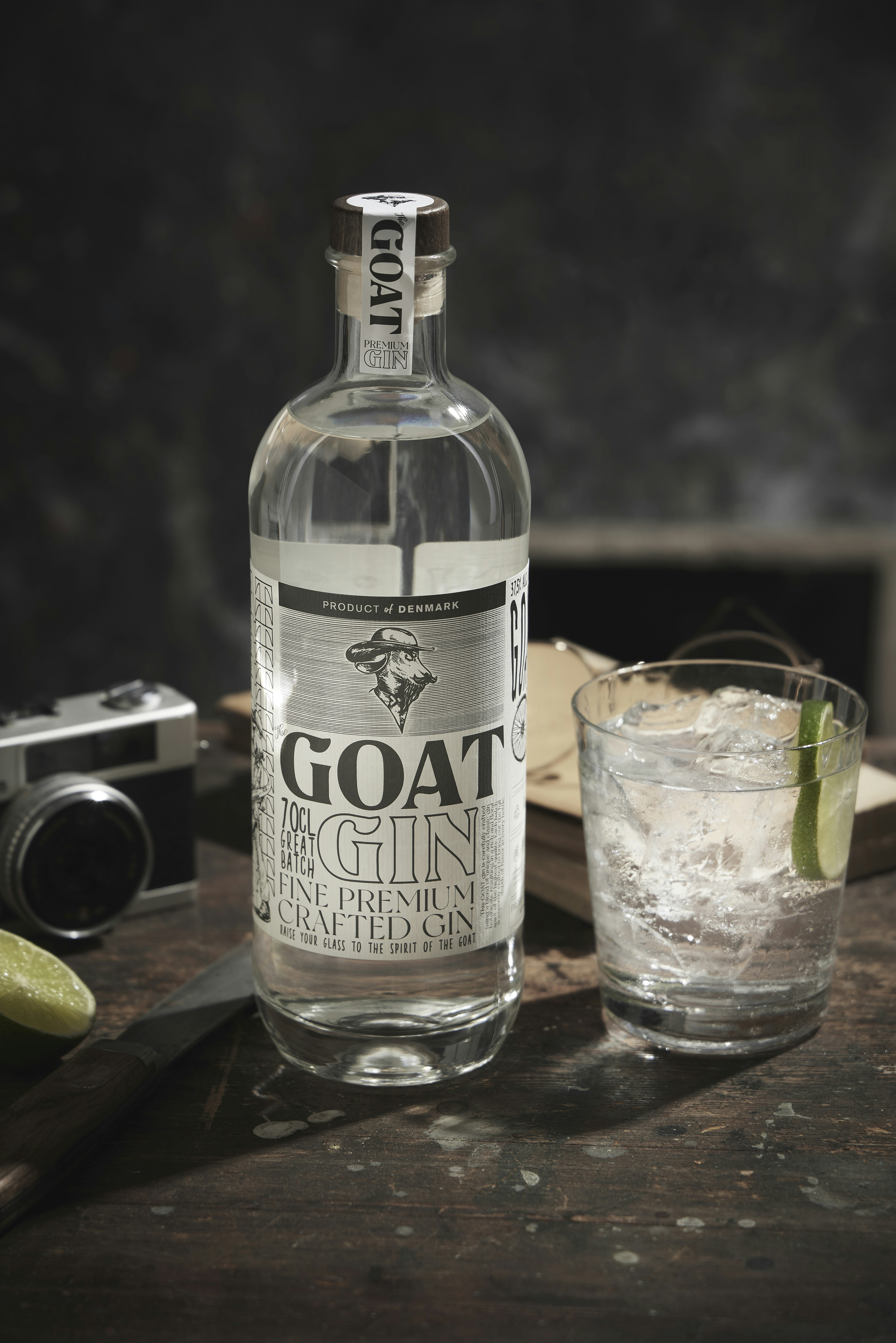 A bottle of goat gin next to a glass of gin photo – Free Gin Image on ...