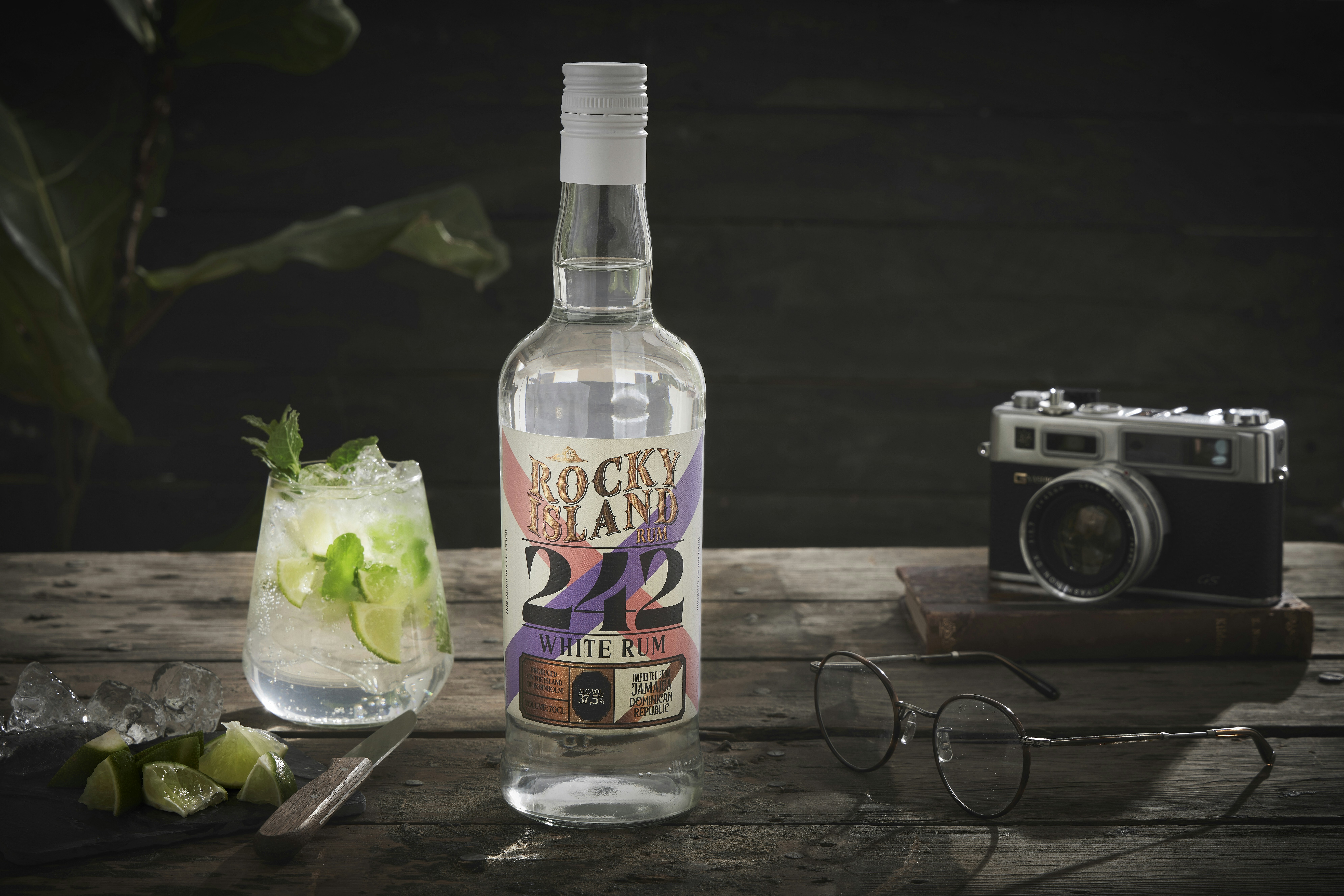 A bottle of alcohol next to a glass and a camera photo – Free Cocktail ...