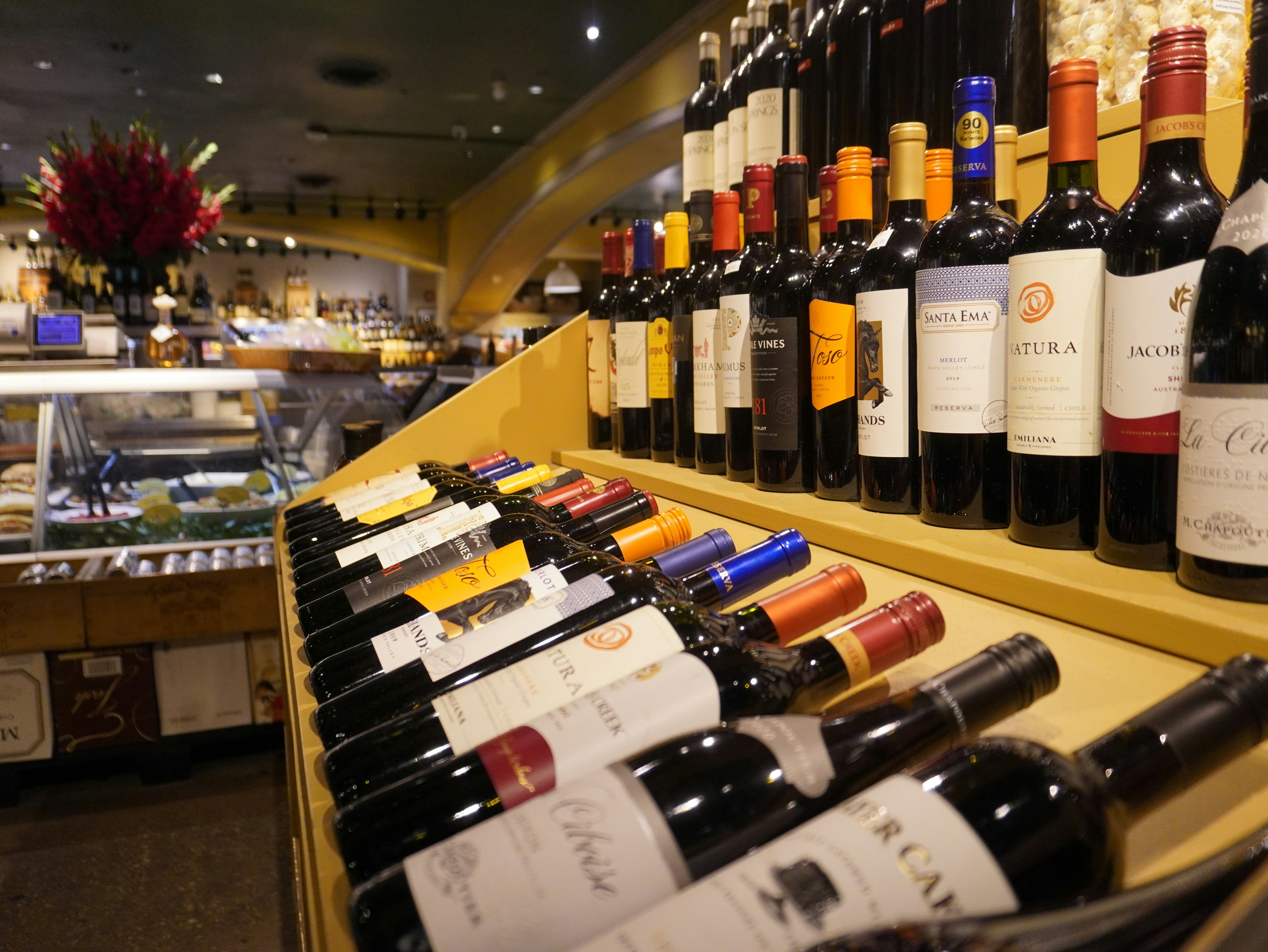 A bunch of bottles of wine on a shelf photo – Free Human Image on Unsplash