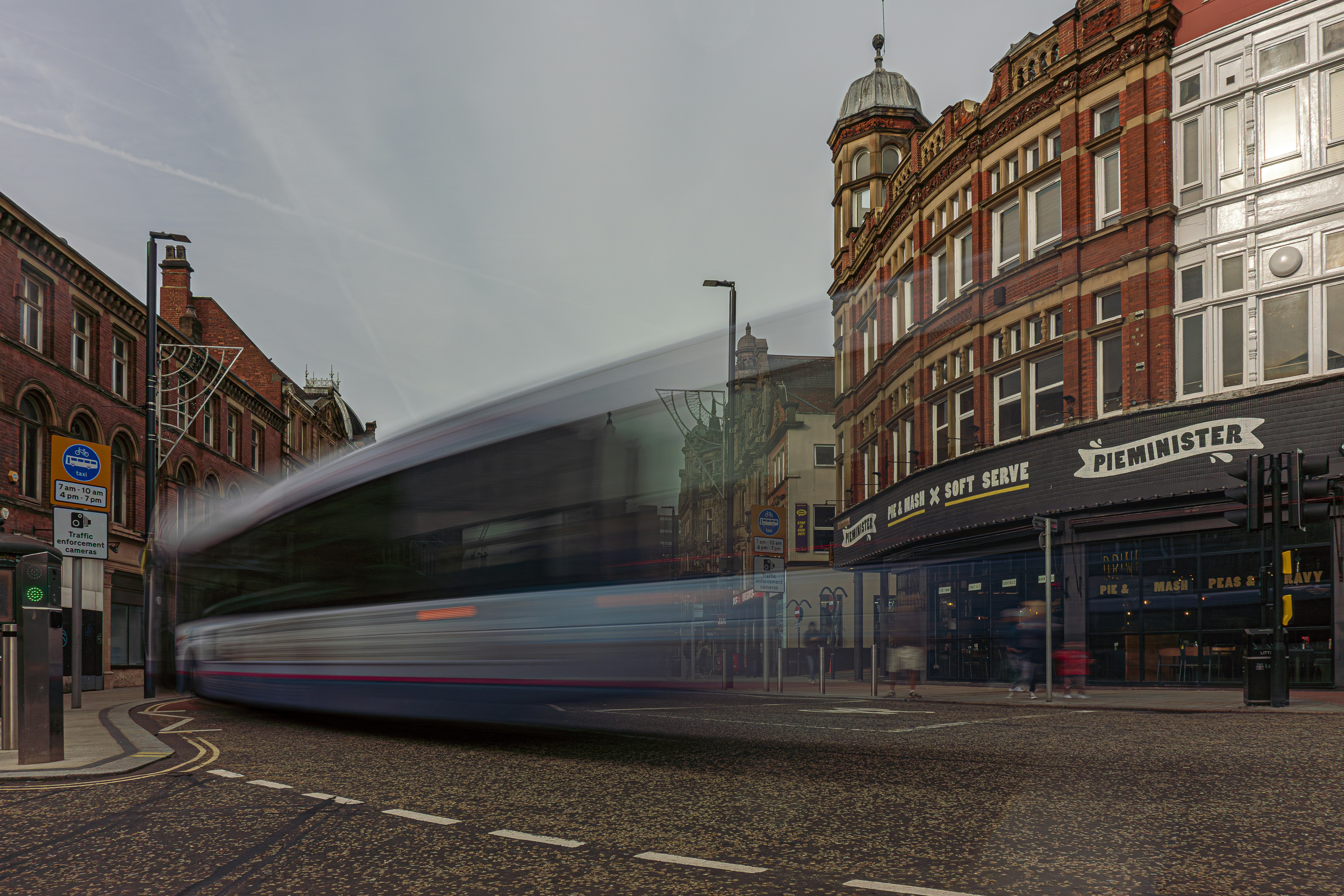 A blurry photo of a bus on a city street photo – Free Leeds Image on ...