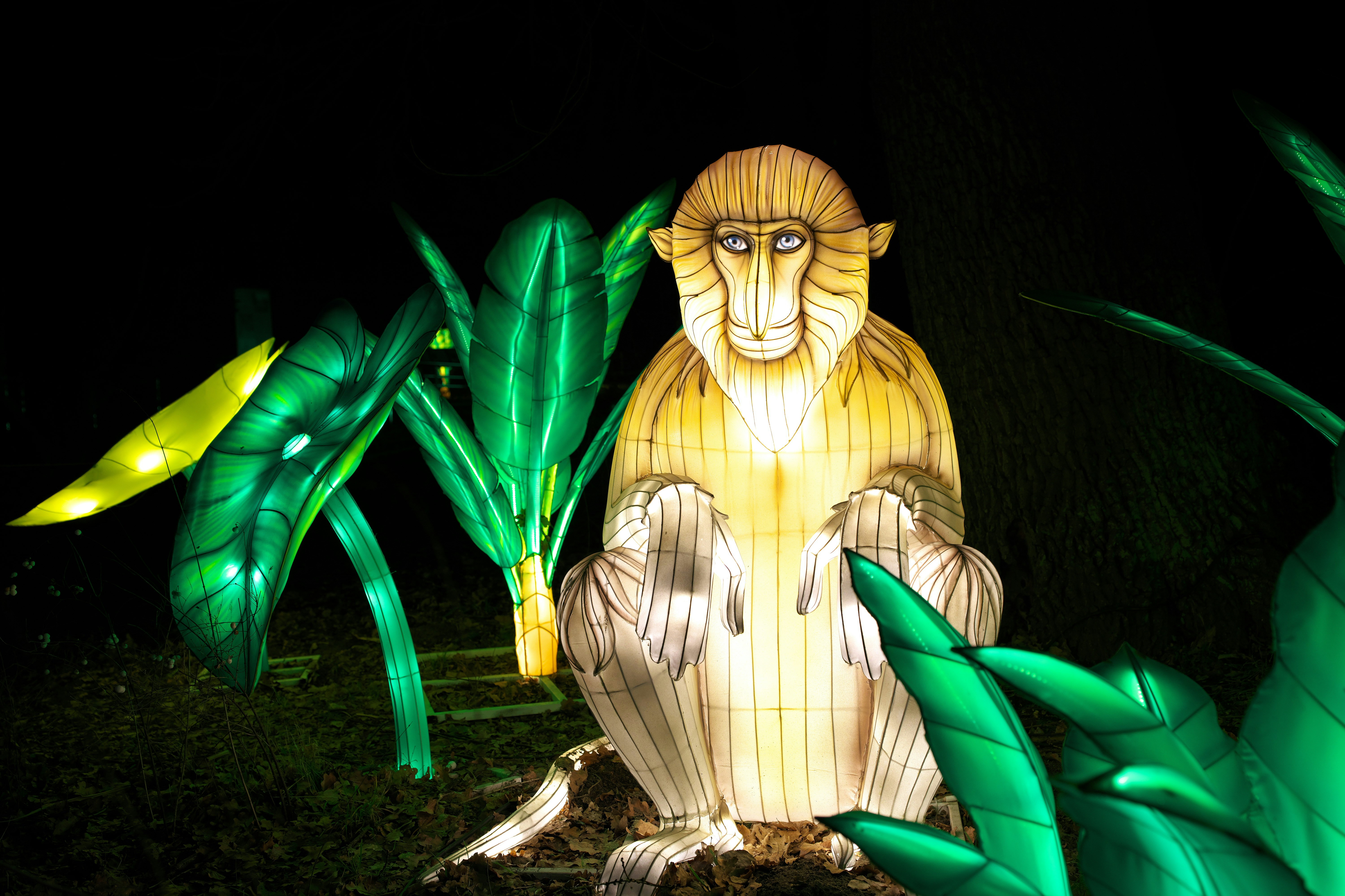 A statue of a monkey sitting on top of a plant