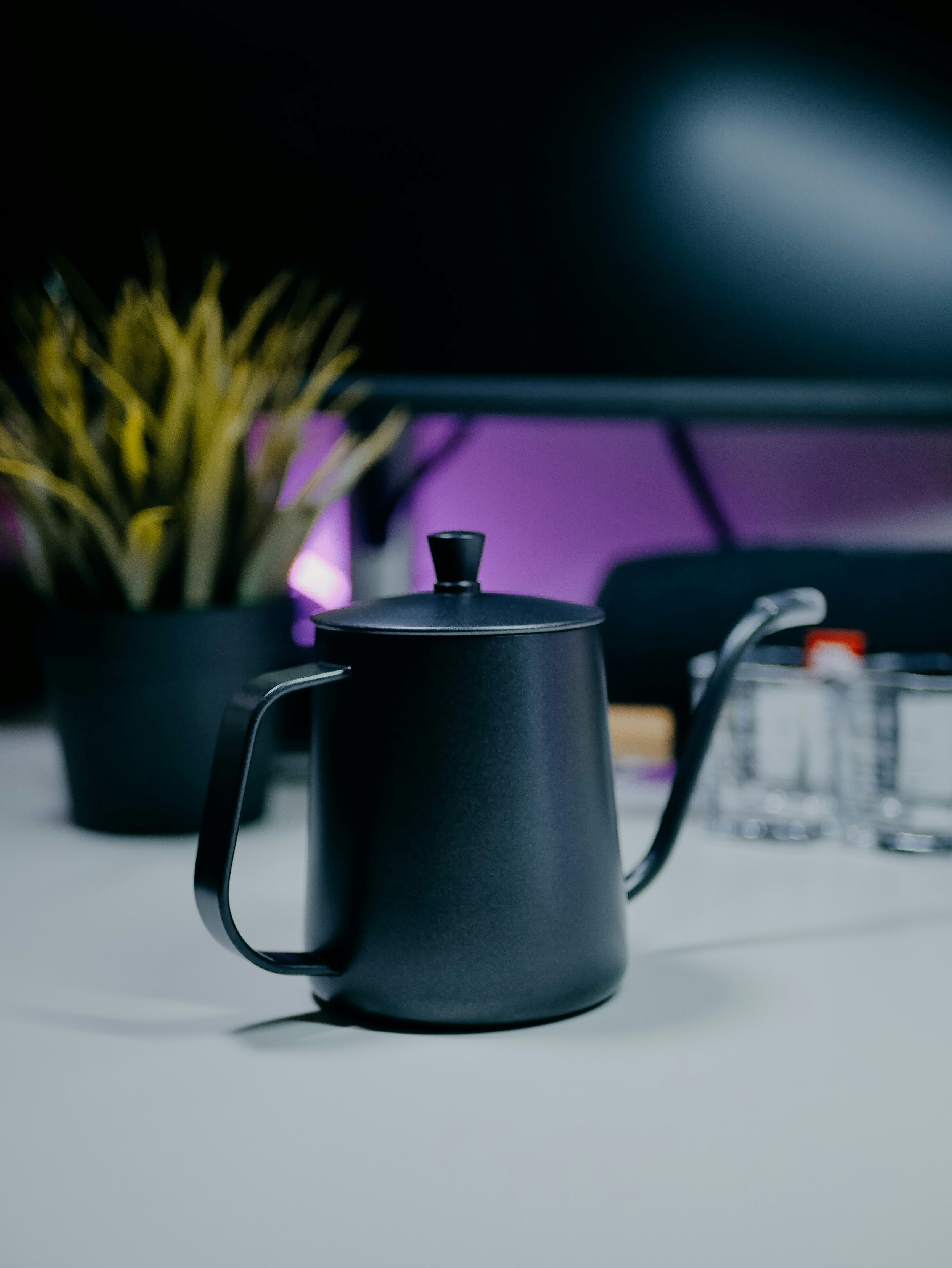 A black coffee pot sitting on top of a white table photo – Free Mokapot ...