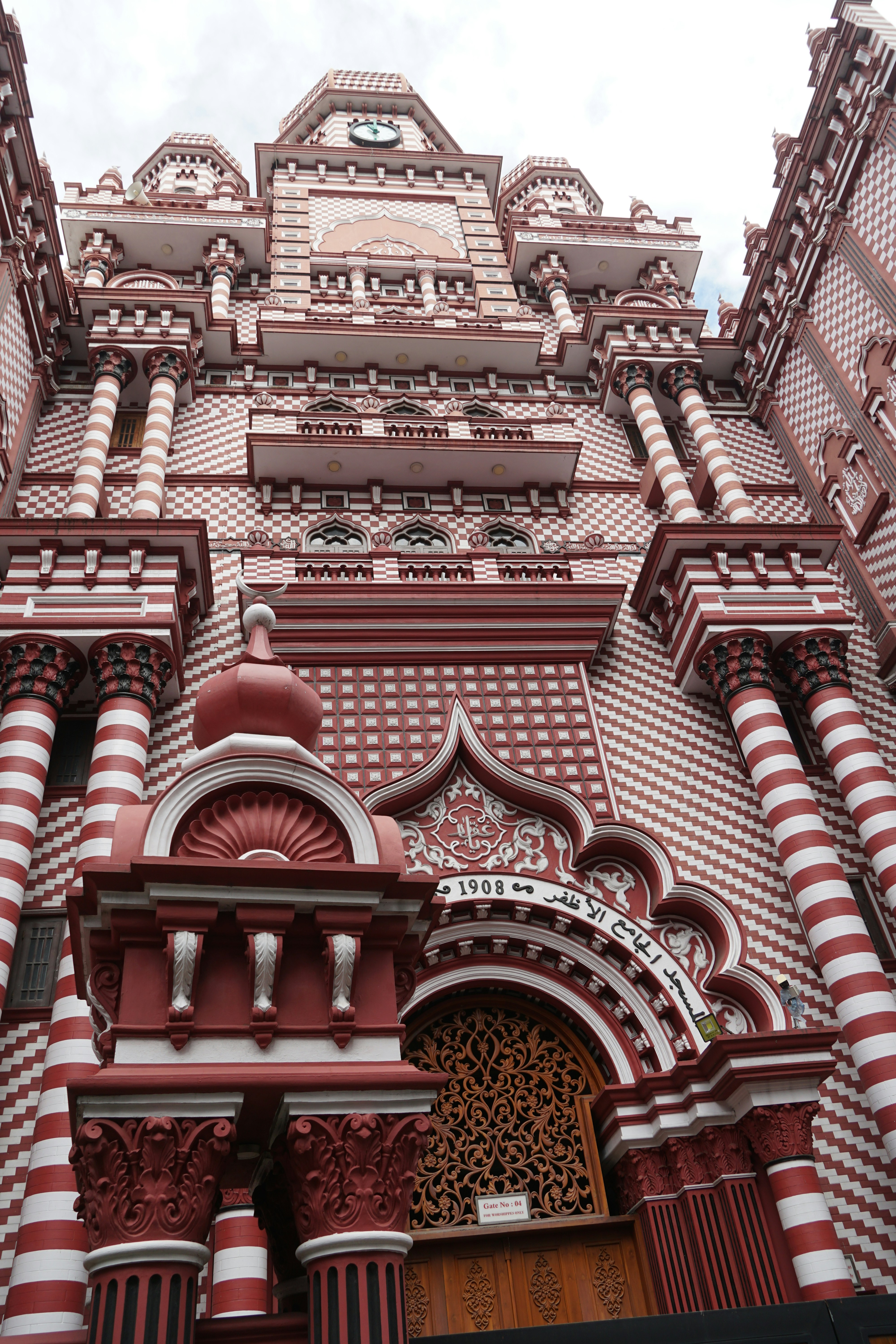 Checkerboard Spires: A Red-and-White Facade Reaching Skyward