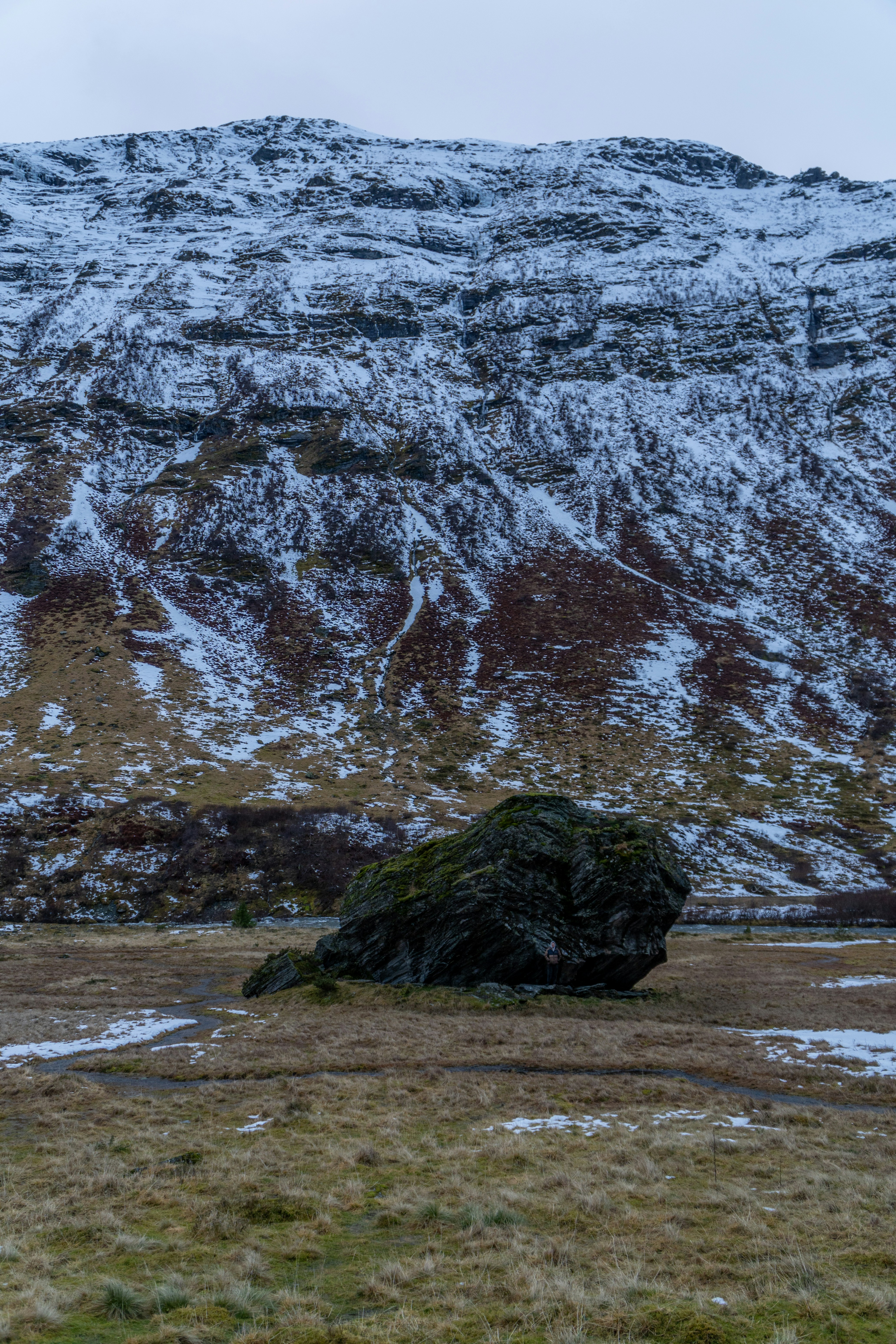 Solitary Boulder Beneath Snow-Dusted Slope