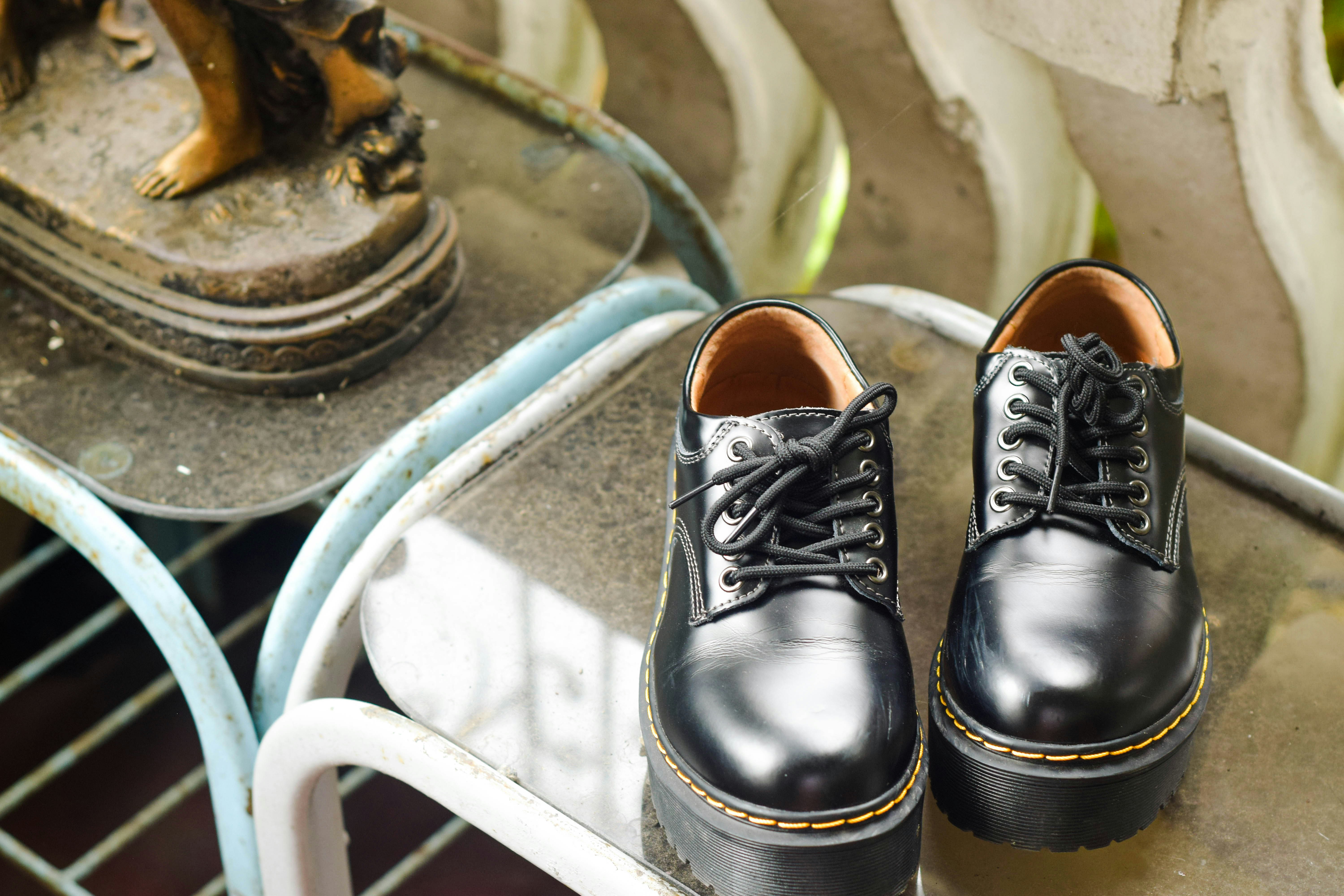 Contrasts of Elegance: Polished Shoes Amidst Rustic Details