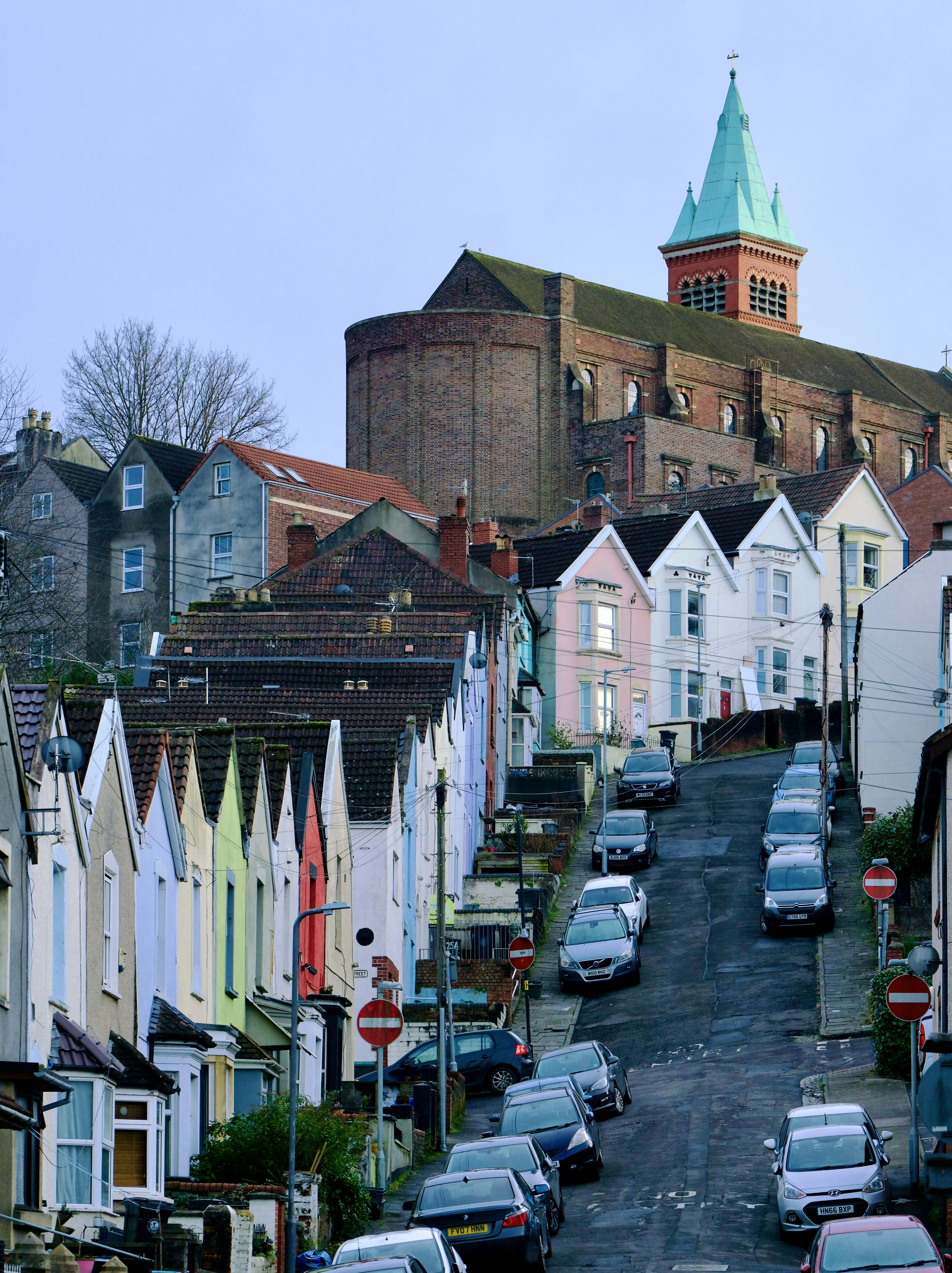 Colorful Terrace Climb: A Coastal Street toward a Brick Church