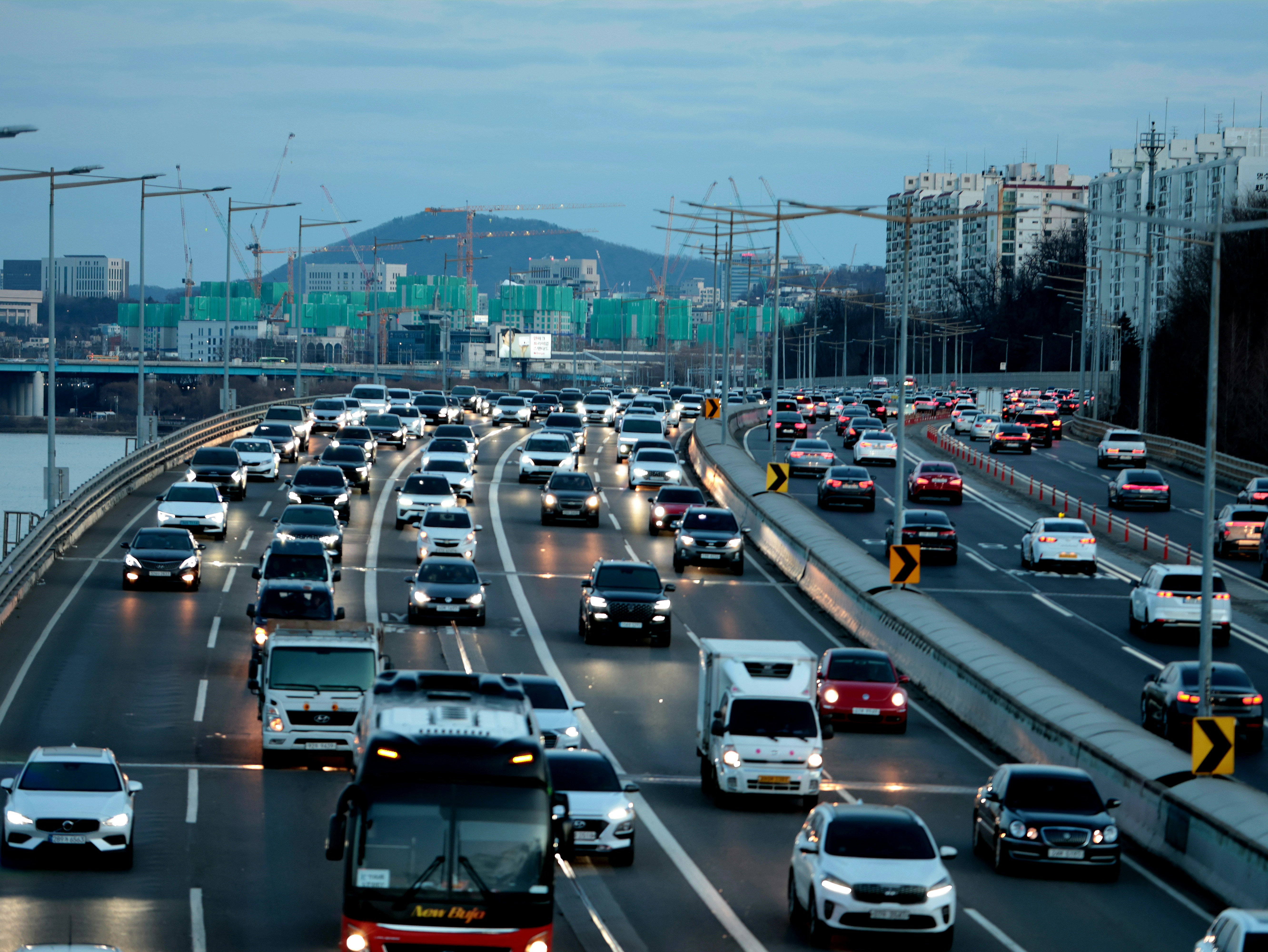 A highway filled with lots of traffic next to tall buildings photo ...