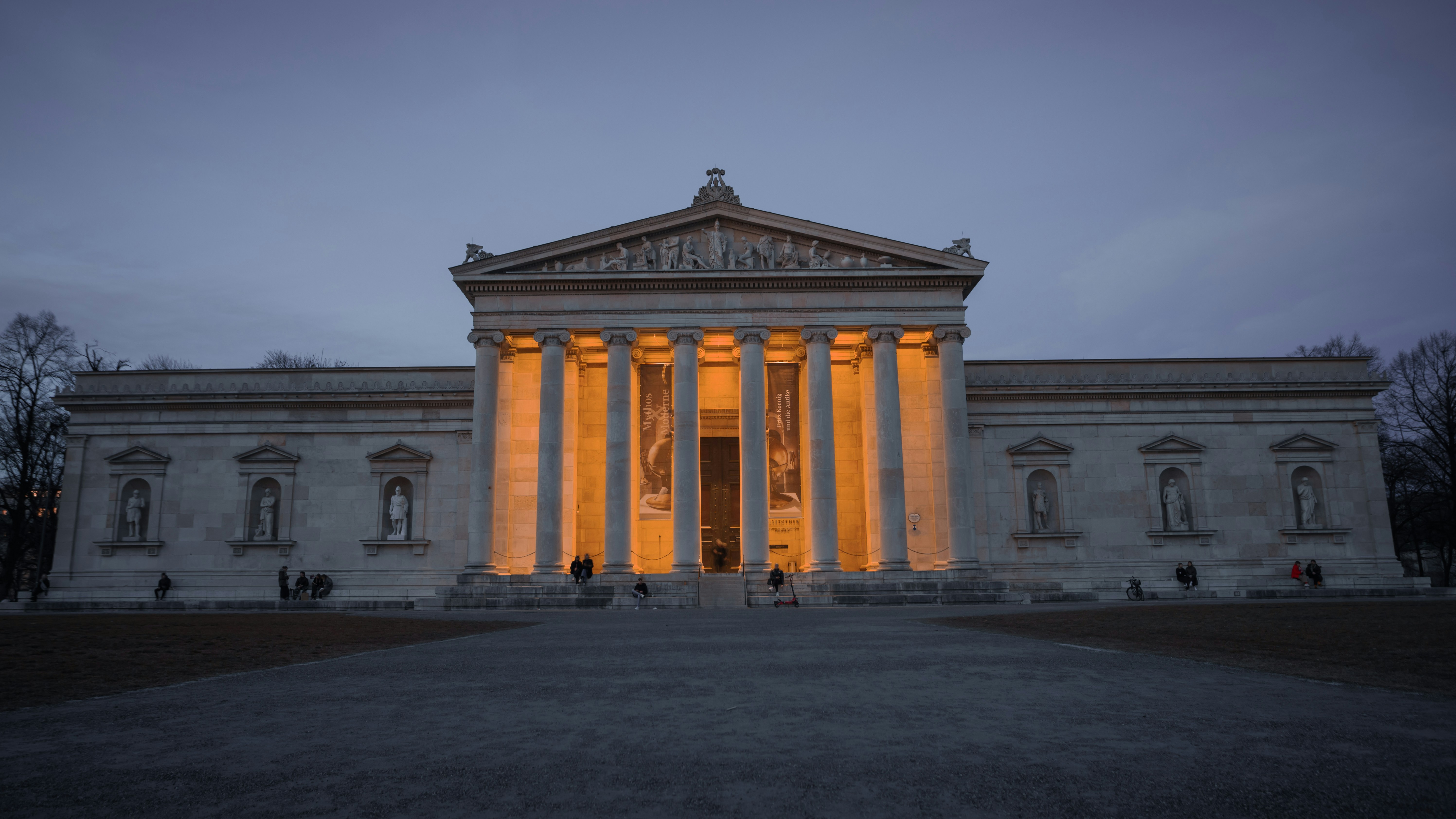 A building with columns lit up at night photo – Free Building Image on ...