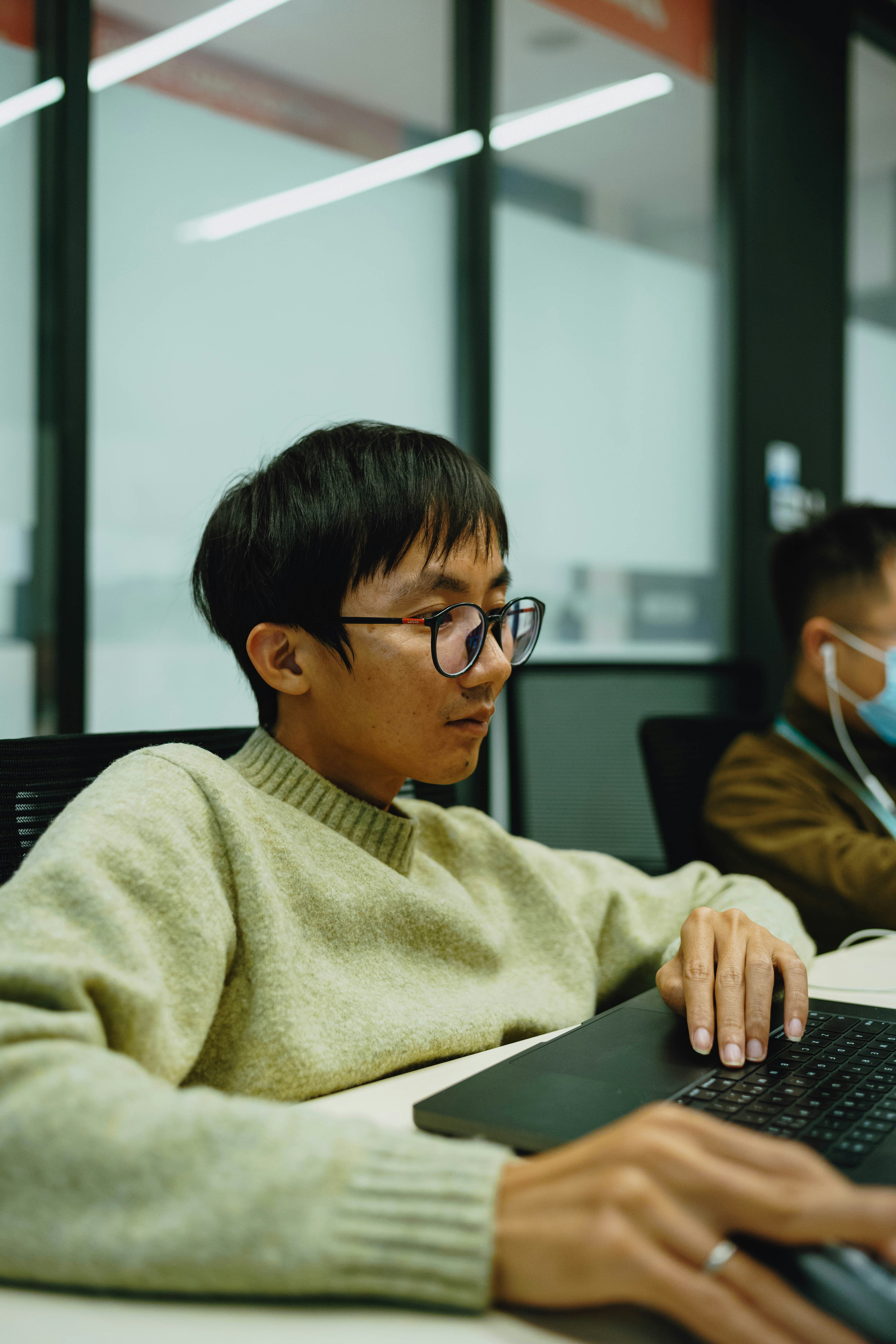 A man sitting in front of a laptop computer photo – Free Portrait Image ...