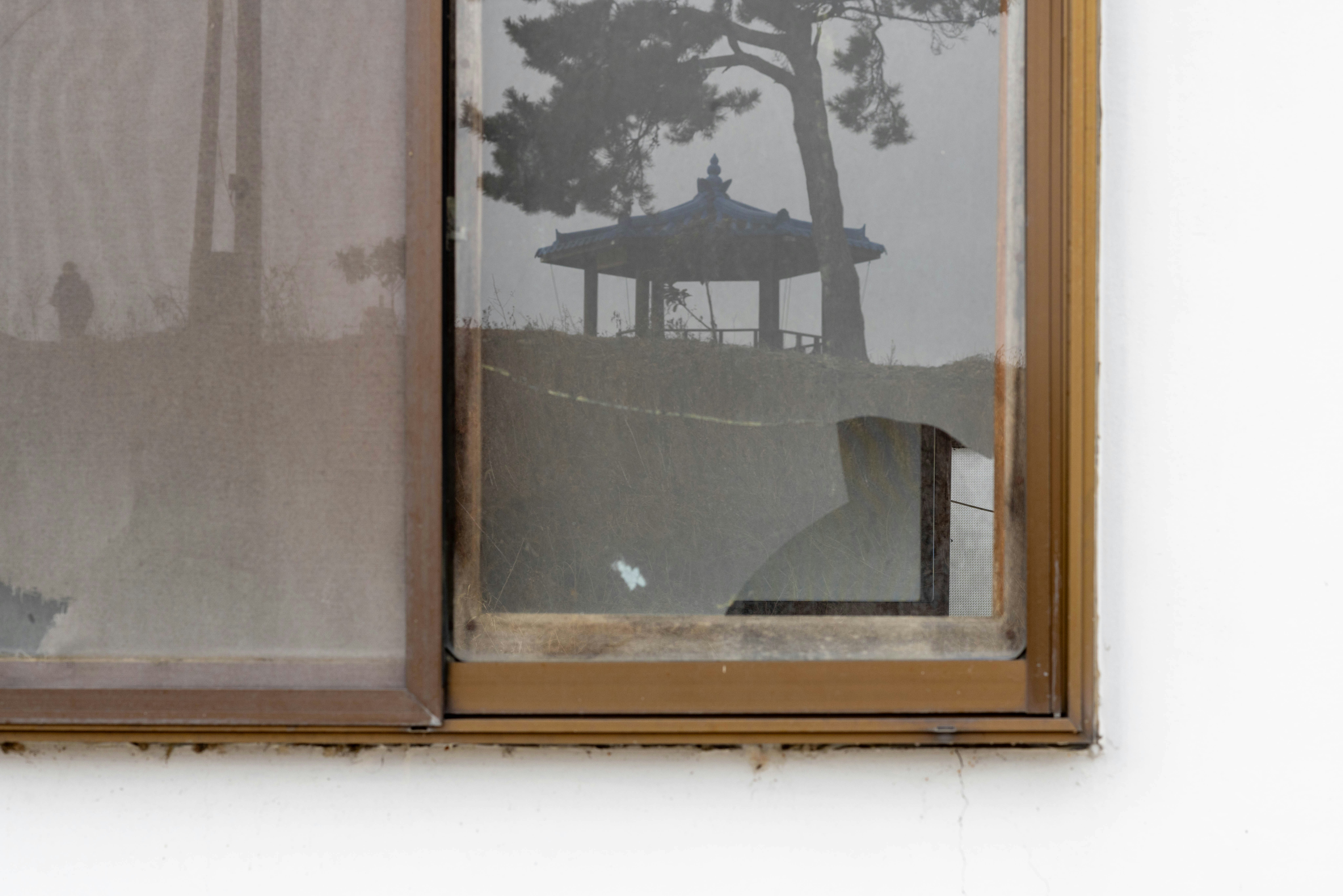 A reflection of a building in a window photo – Free Human Image on Unsplash
