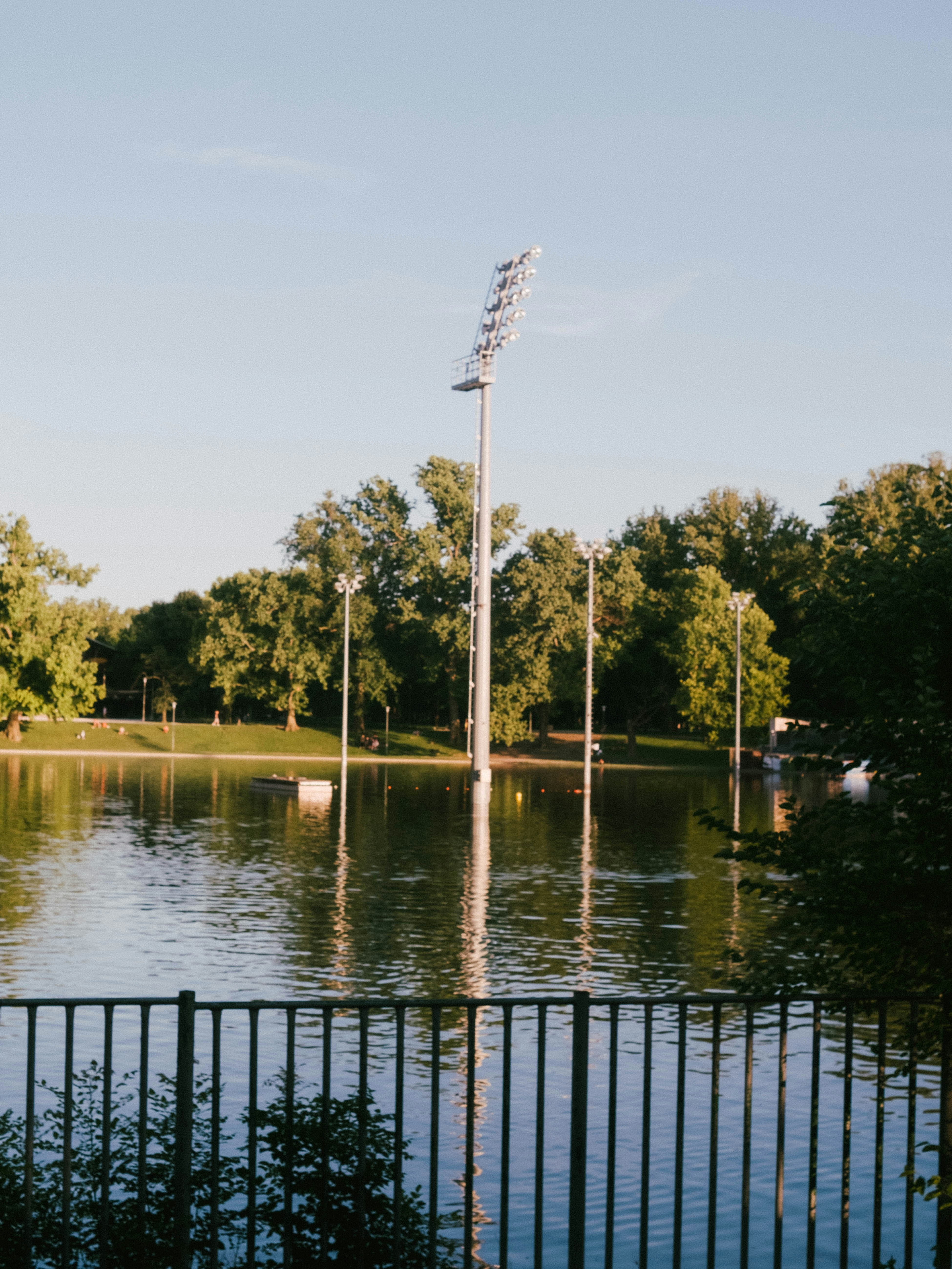 Light Tower Over Calm Water: Riverside Park at Dusk