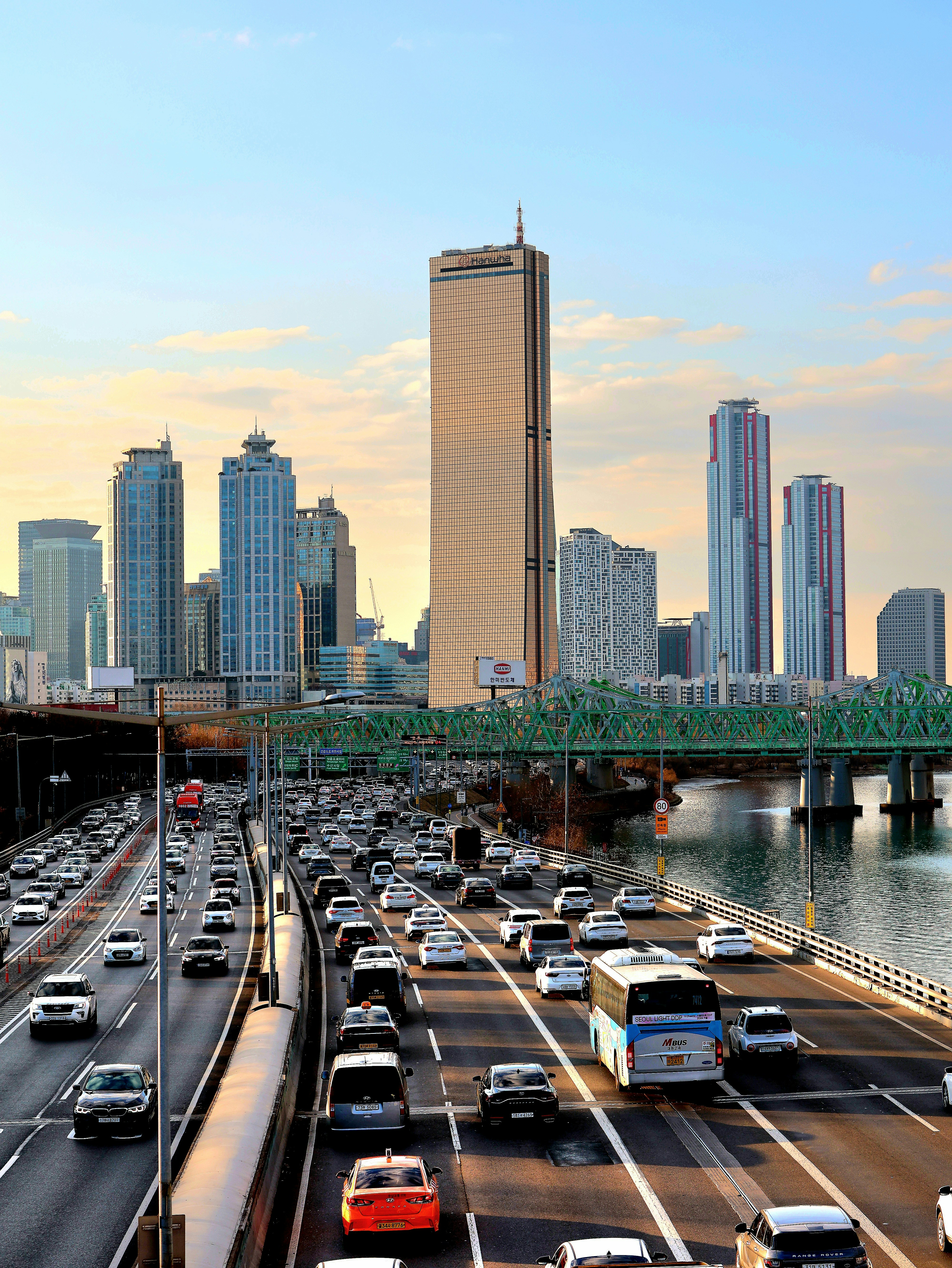 A highway filled with lots of traffic next to tall buildings photo ...