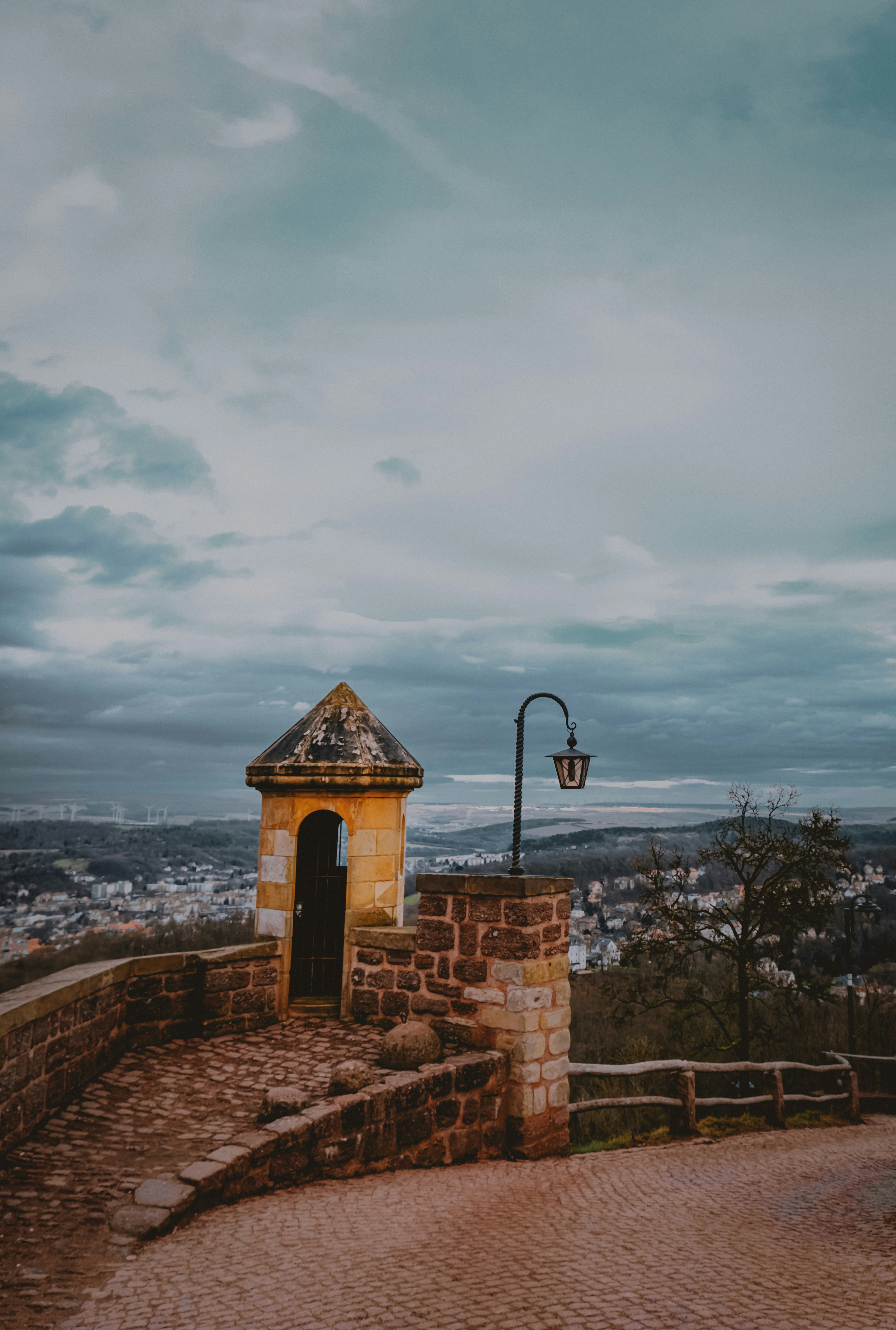 A clock tower sitting on top of a stone wall photo – Free Horizon Image ...