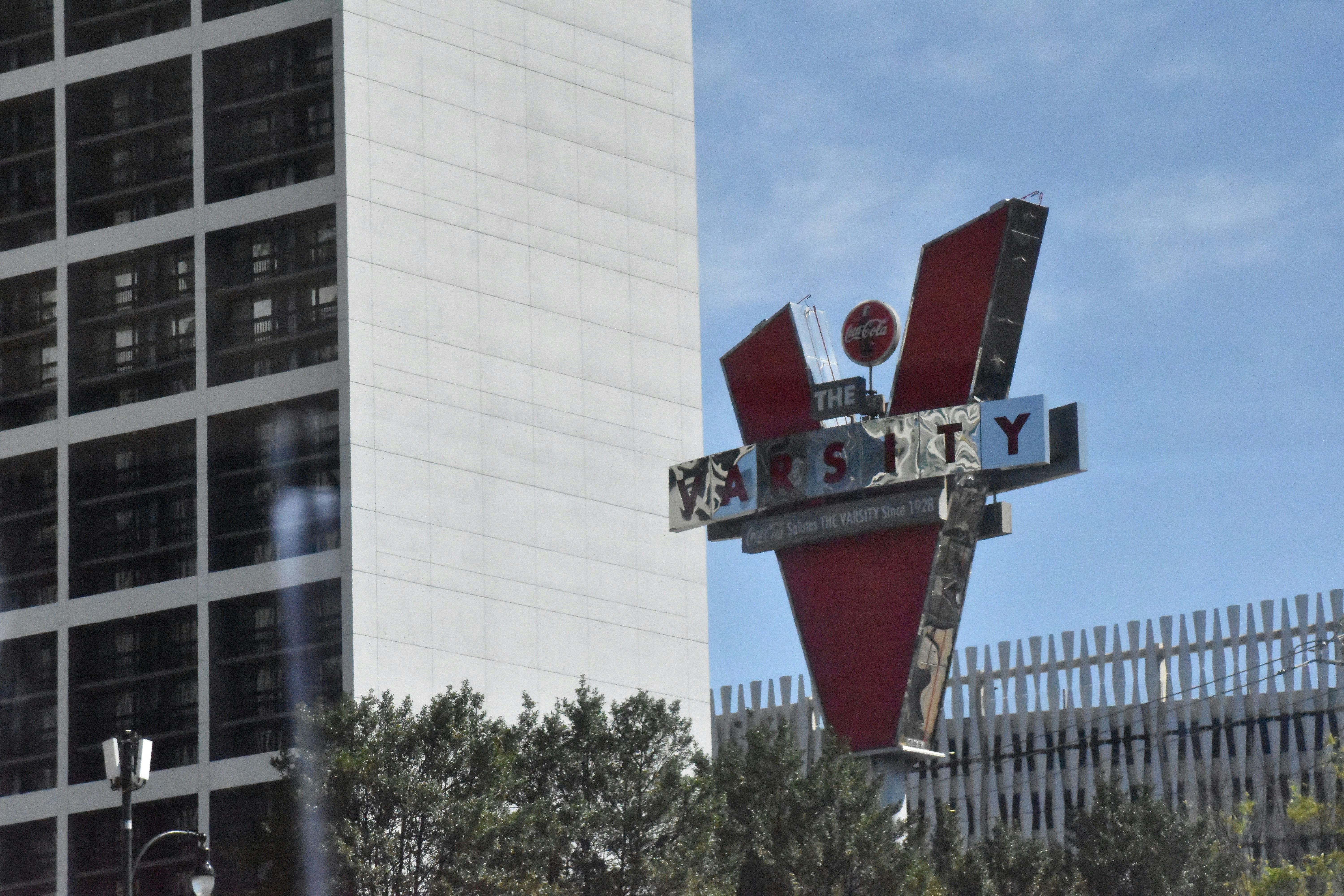 A very tall building with a very large sign on it's side photo – Free ...