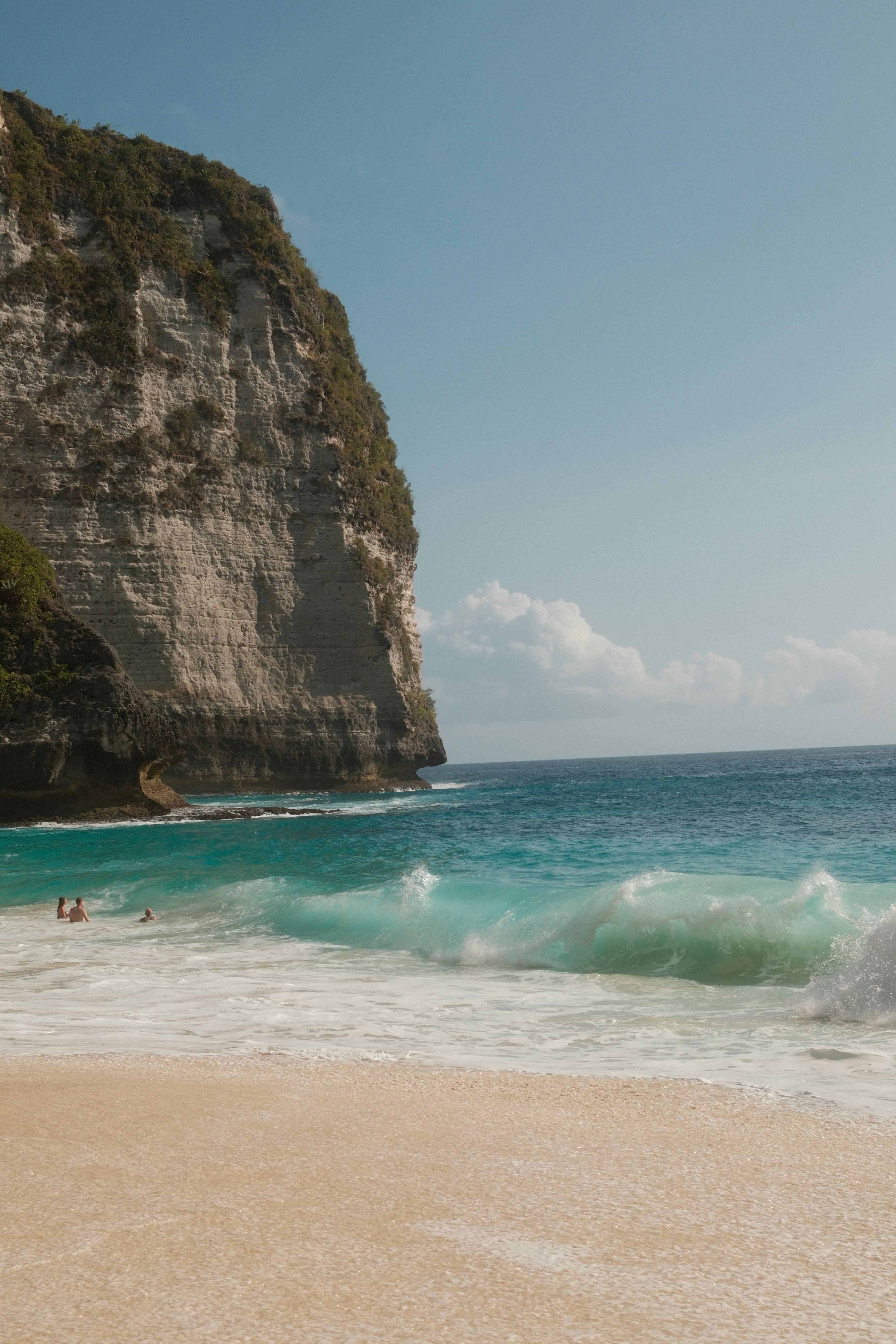Cliffside Crest Over Turquoise Waters at a Quiet Shore